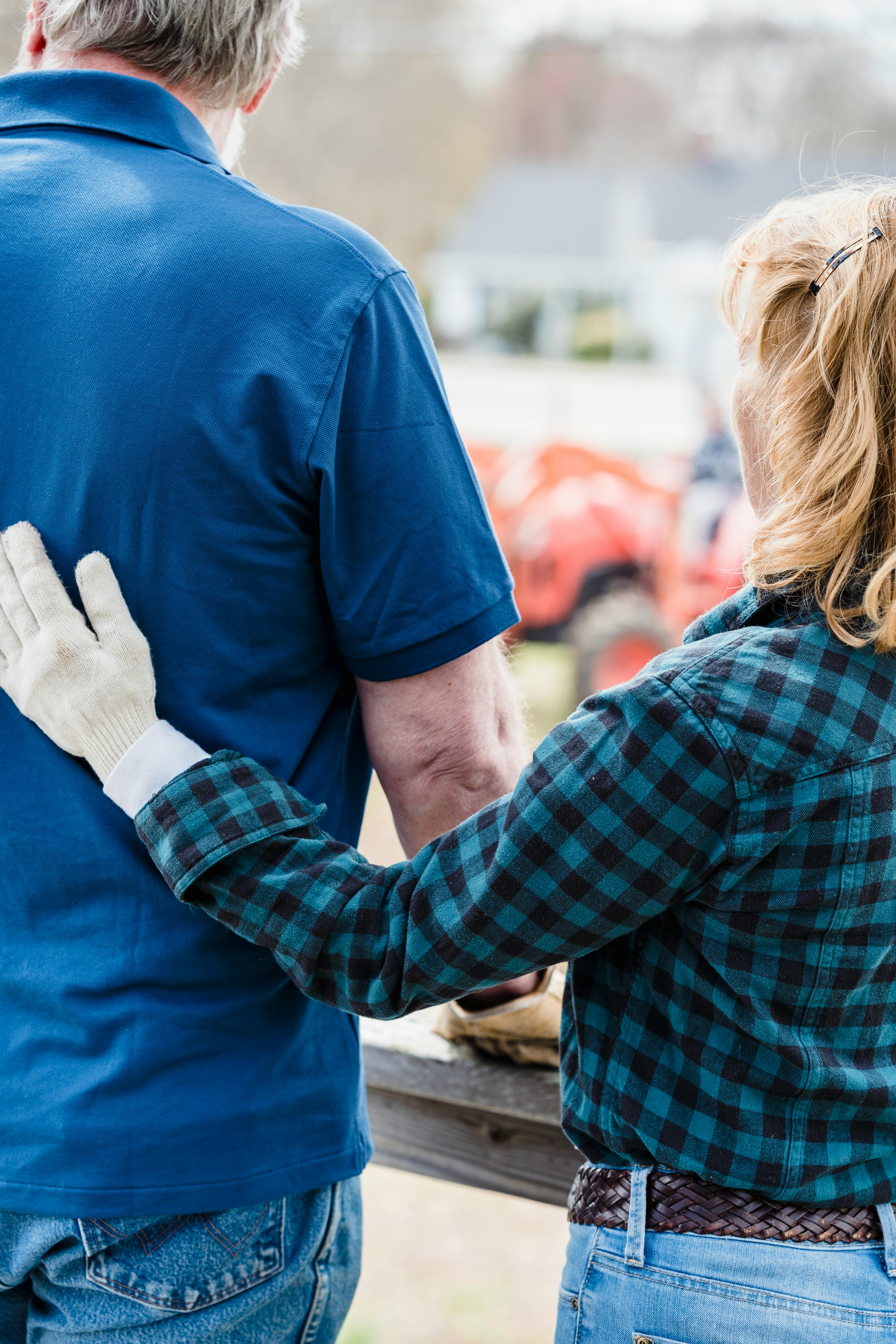 A Woman Holding a Man in His Back · Free Stock Photo