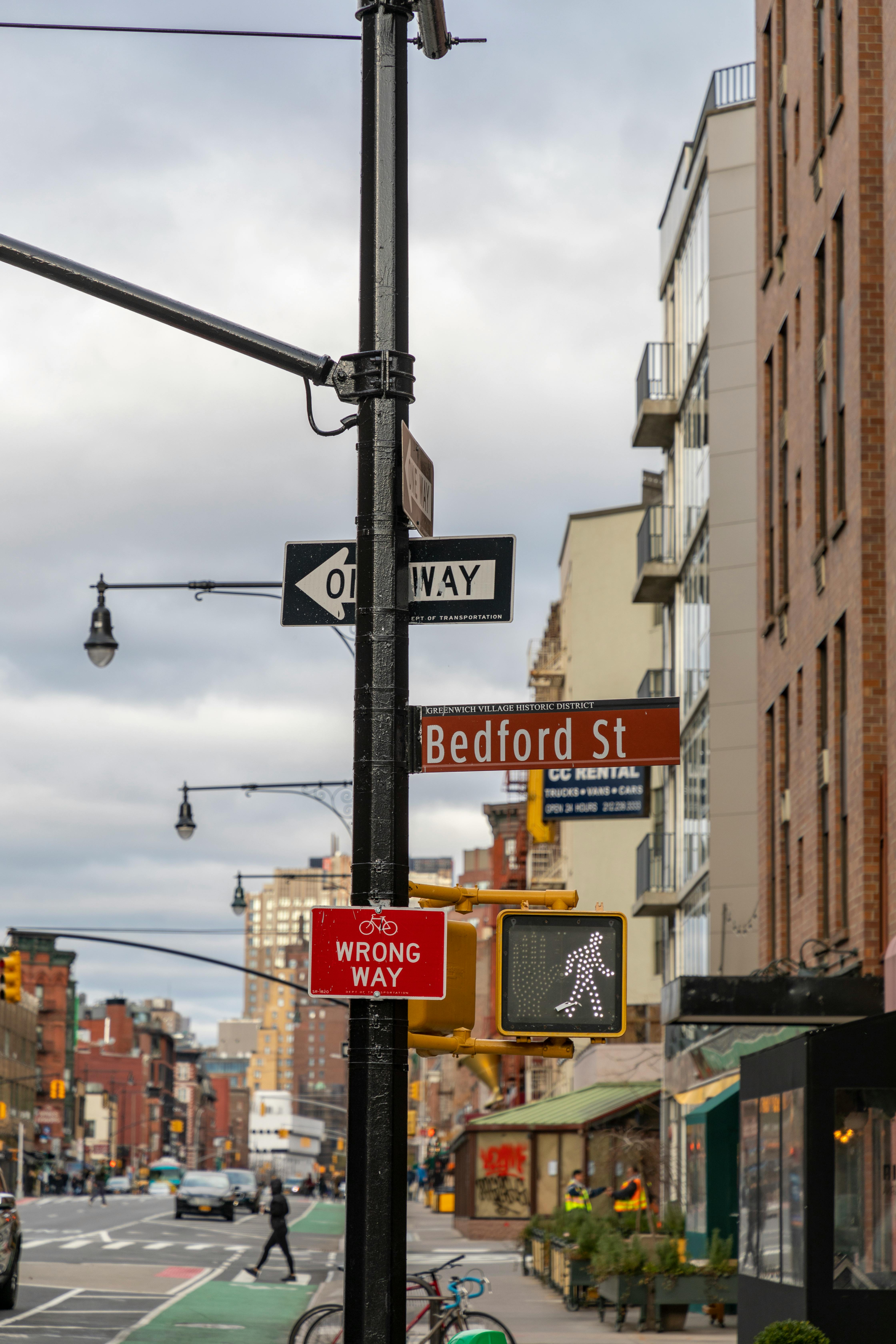 Directional Signs on a Post at a Sidewalk · Free Stock Photo