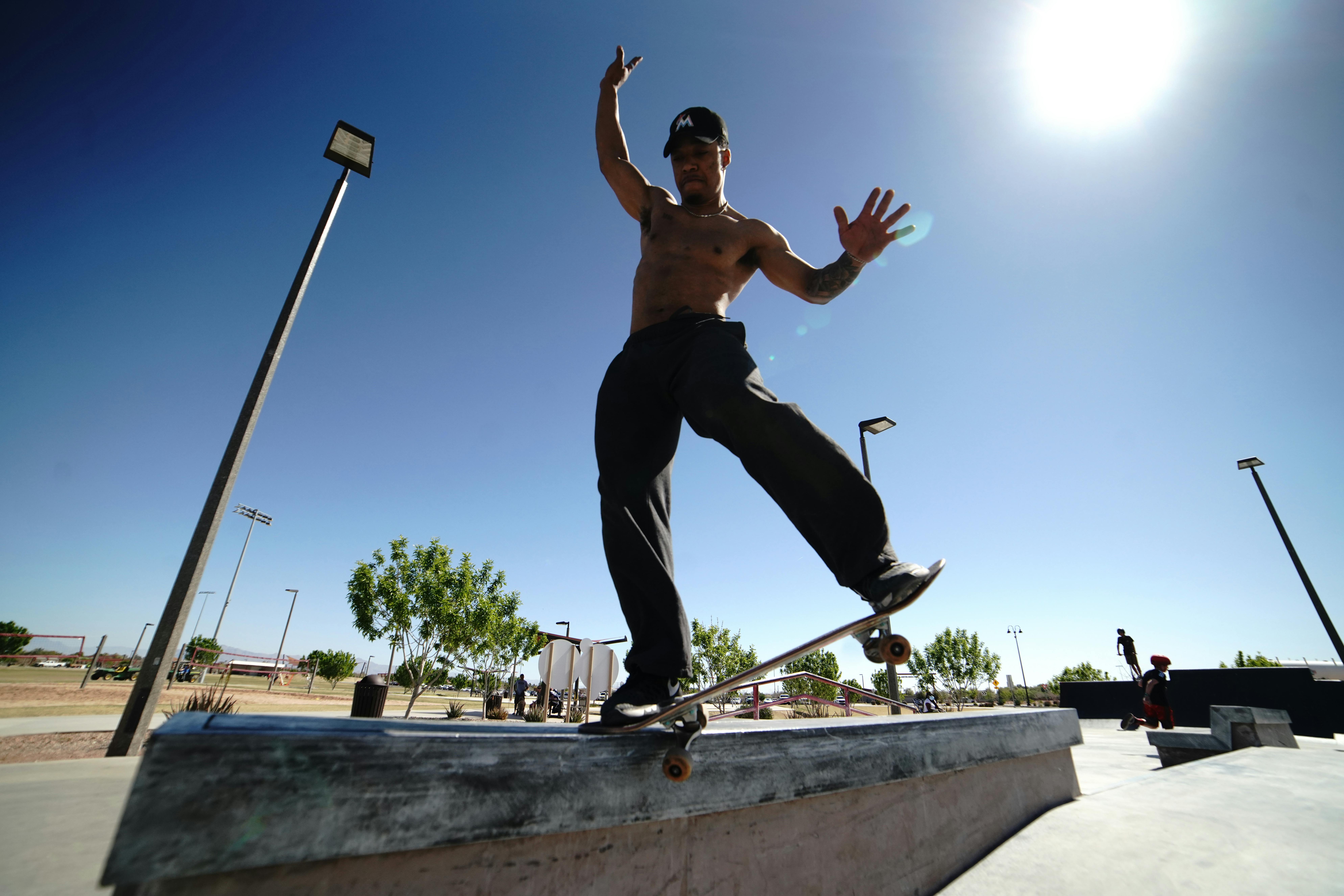 Shirtless Man Doing Tricks on a Skateboard in a Skatepark · Free Stock ...