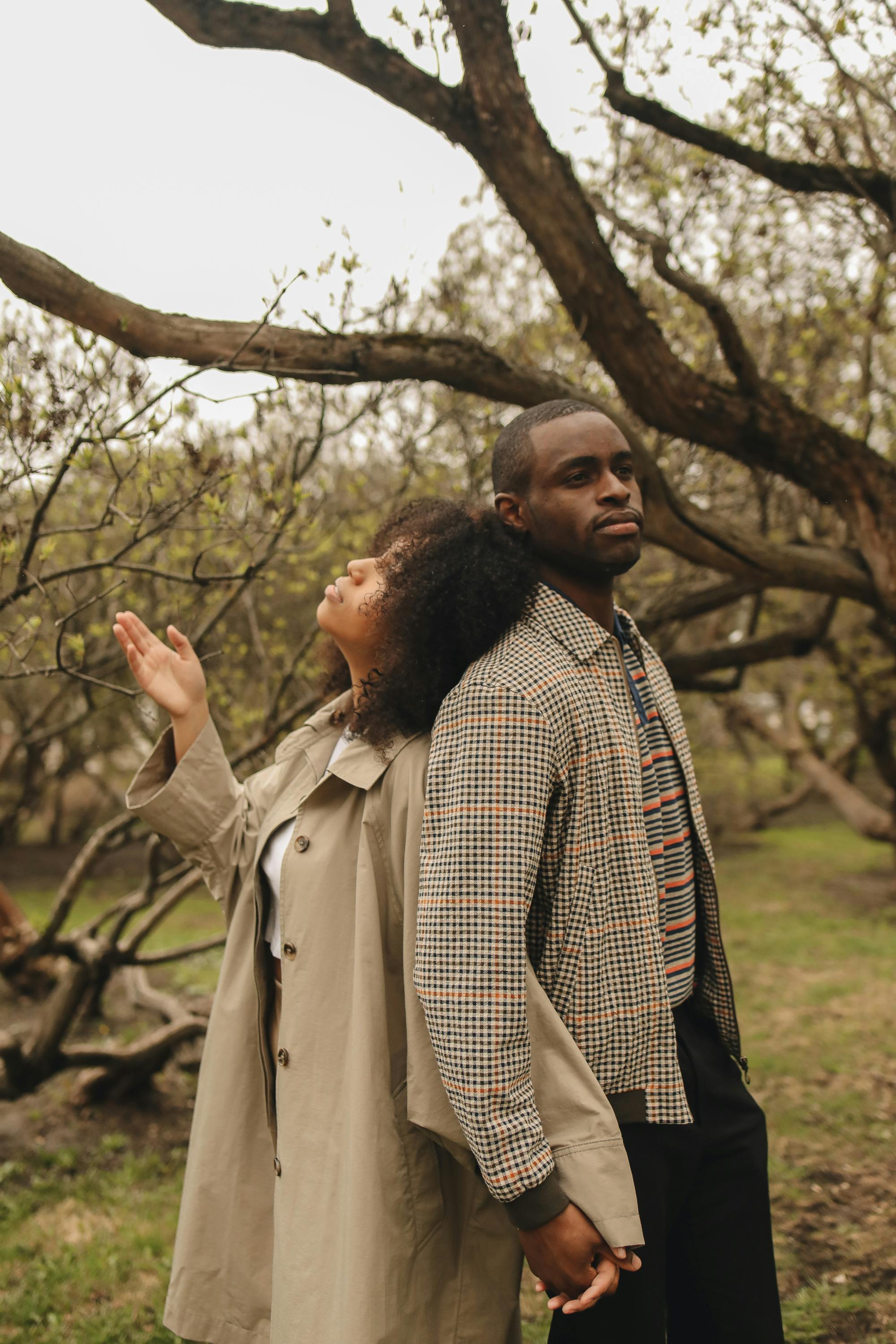 A Couple Standing Back to Back · Free Stock Photo