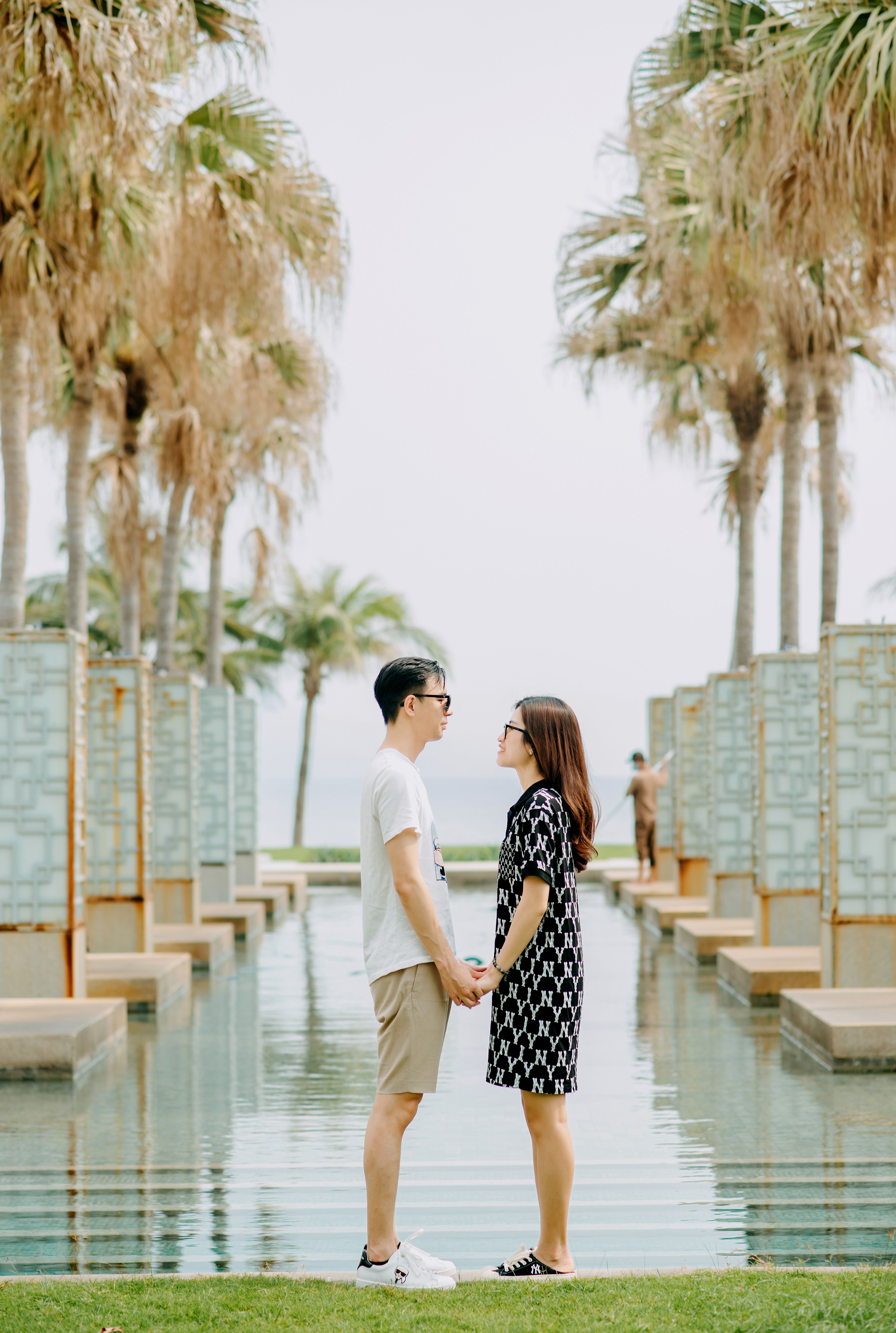 Romantic couple near pool holding hands · Free Stock Photo