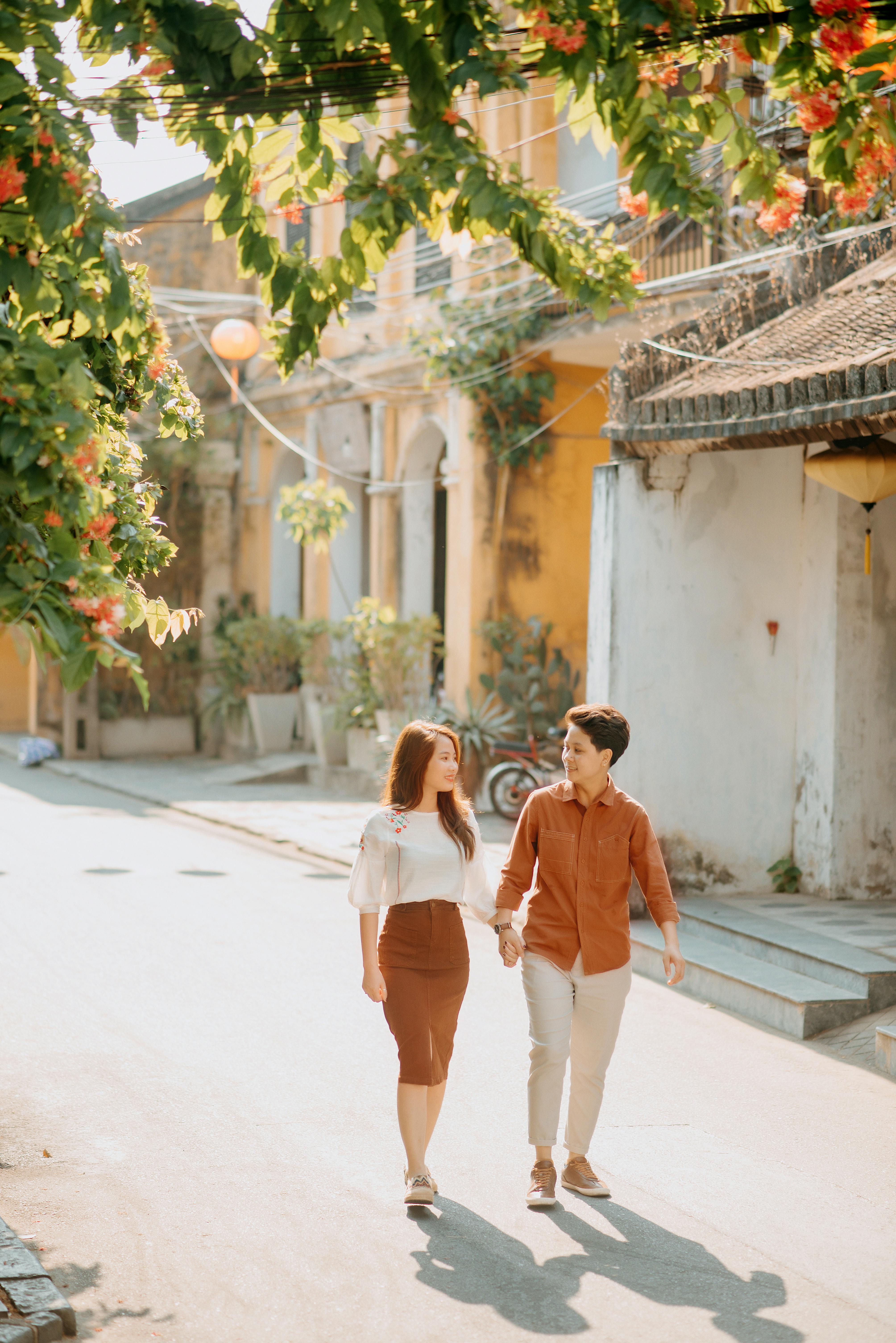 A Couple Holding Hands while Walking · Free Stock Photo