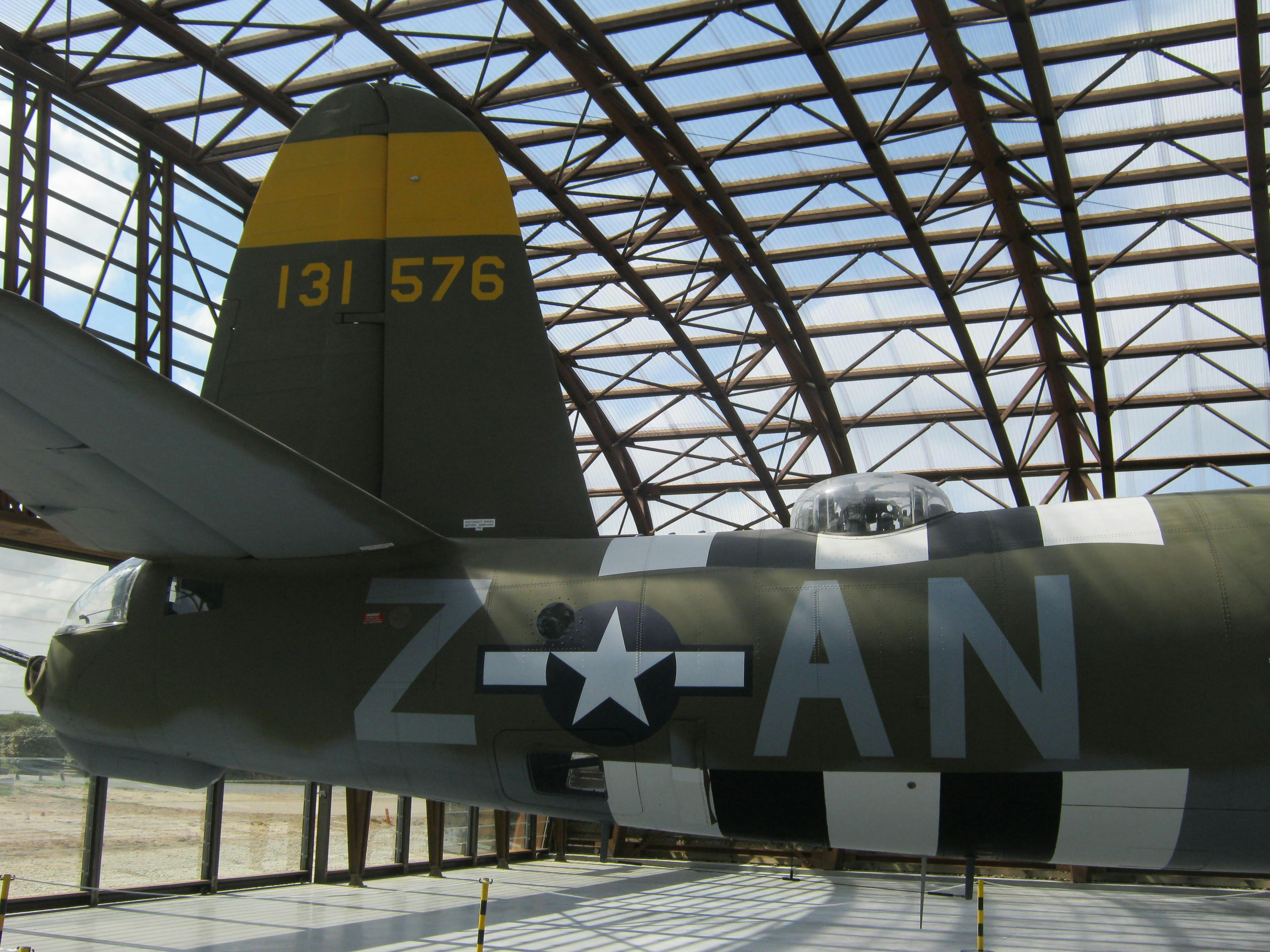 A Gray Fighter Jet Parked Inside Steel Parking Garage · Free Stock Photo