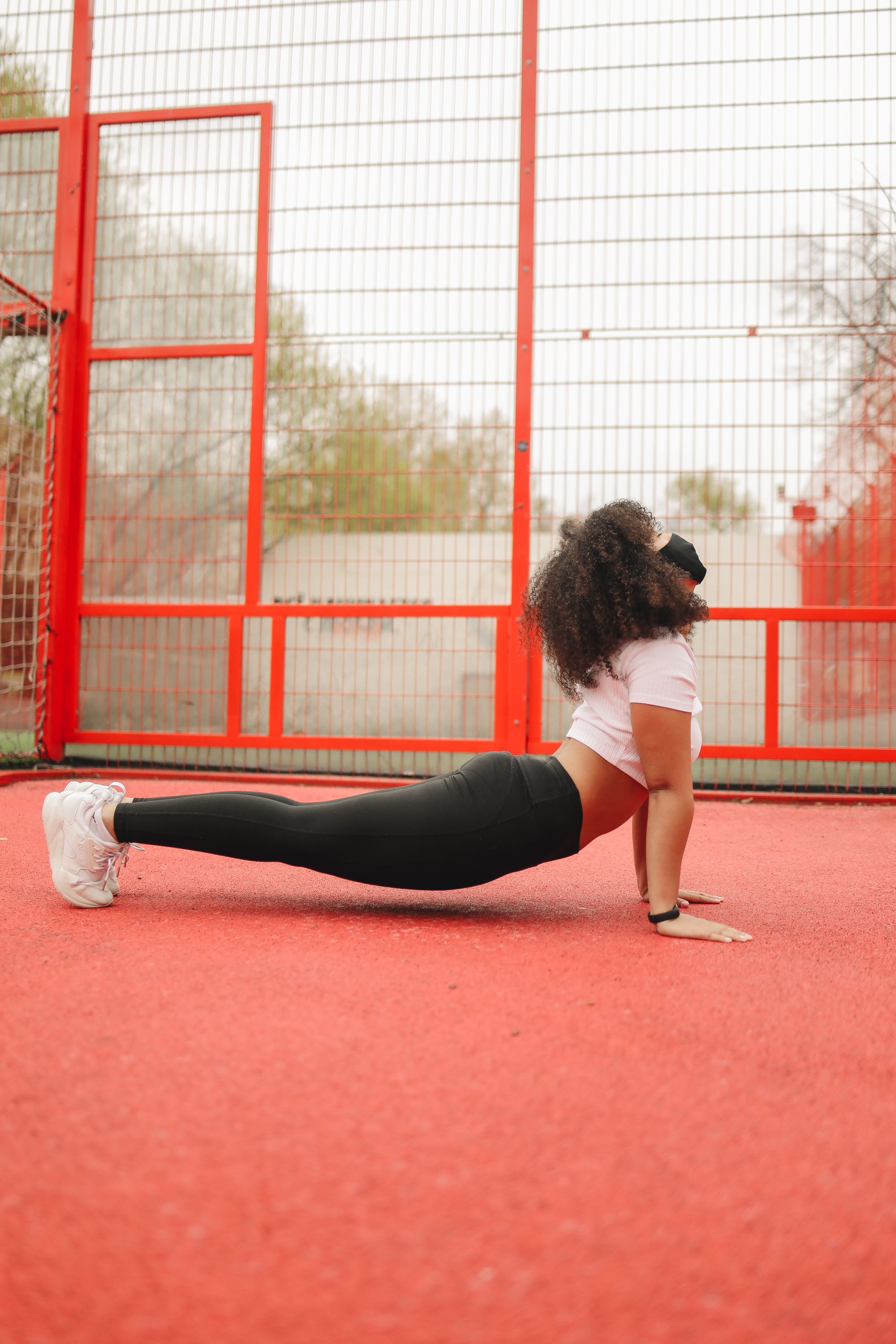 A Woman Stretching while Wearing a Face Mask · Free Stock Photo