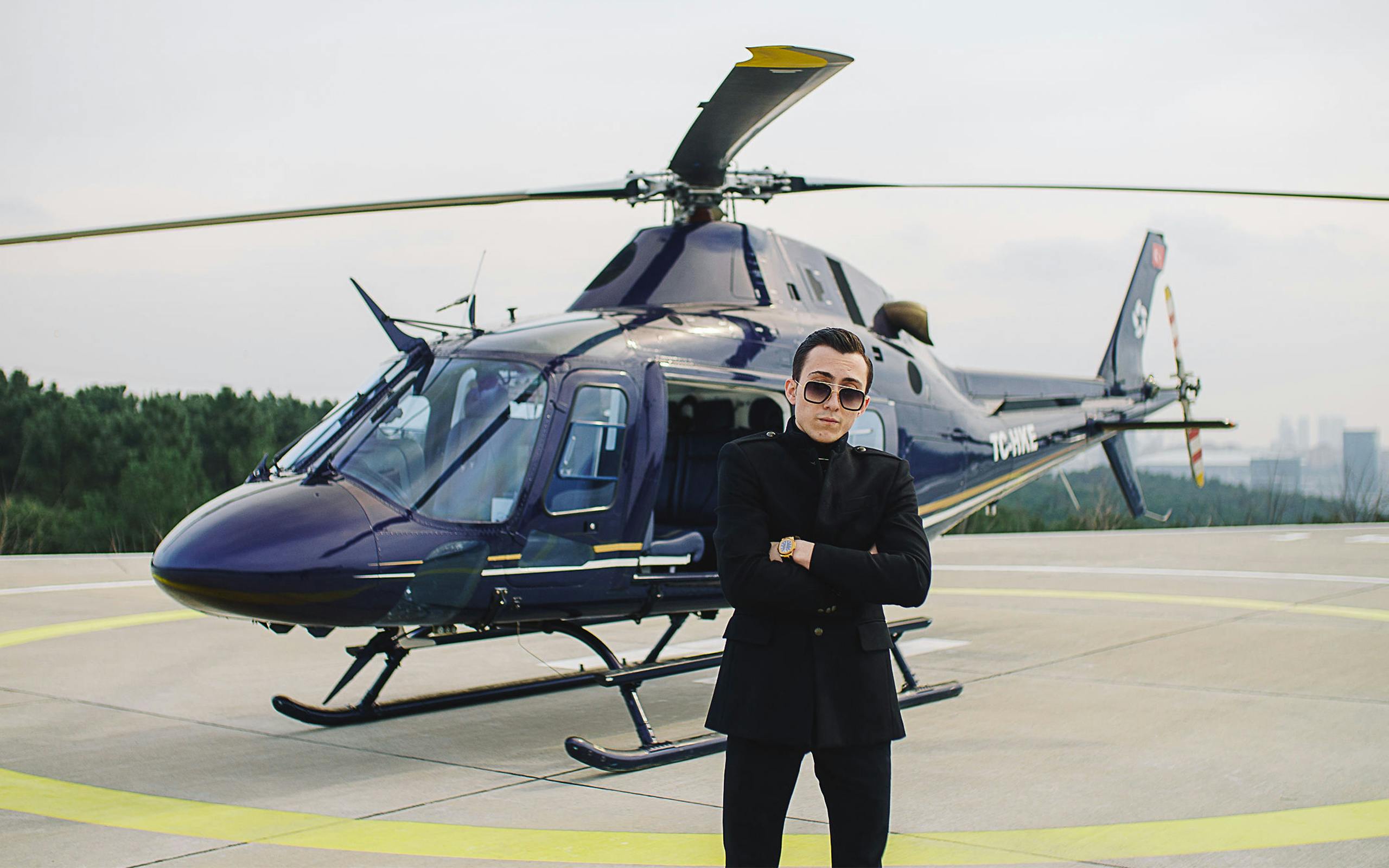 A Man Wearing a Black Outfit Standing beside a Helicopter · Free Stock ...