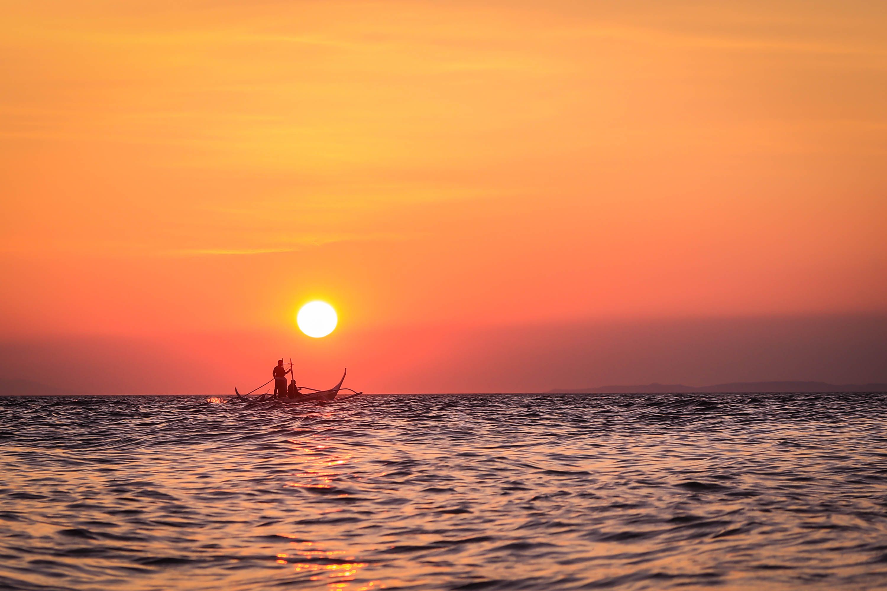 Silhouette of Person on Boat during Sunset · Free Stock Photo