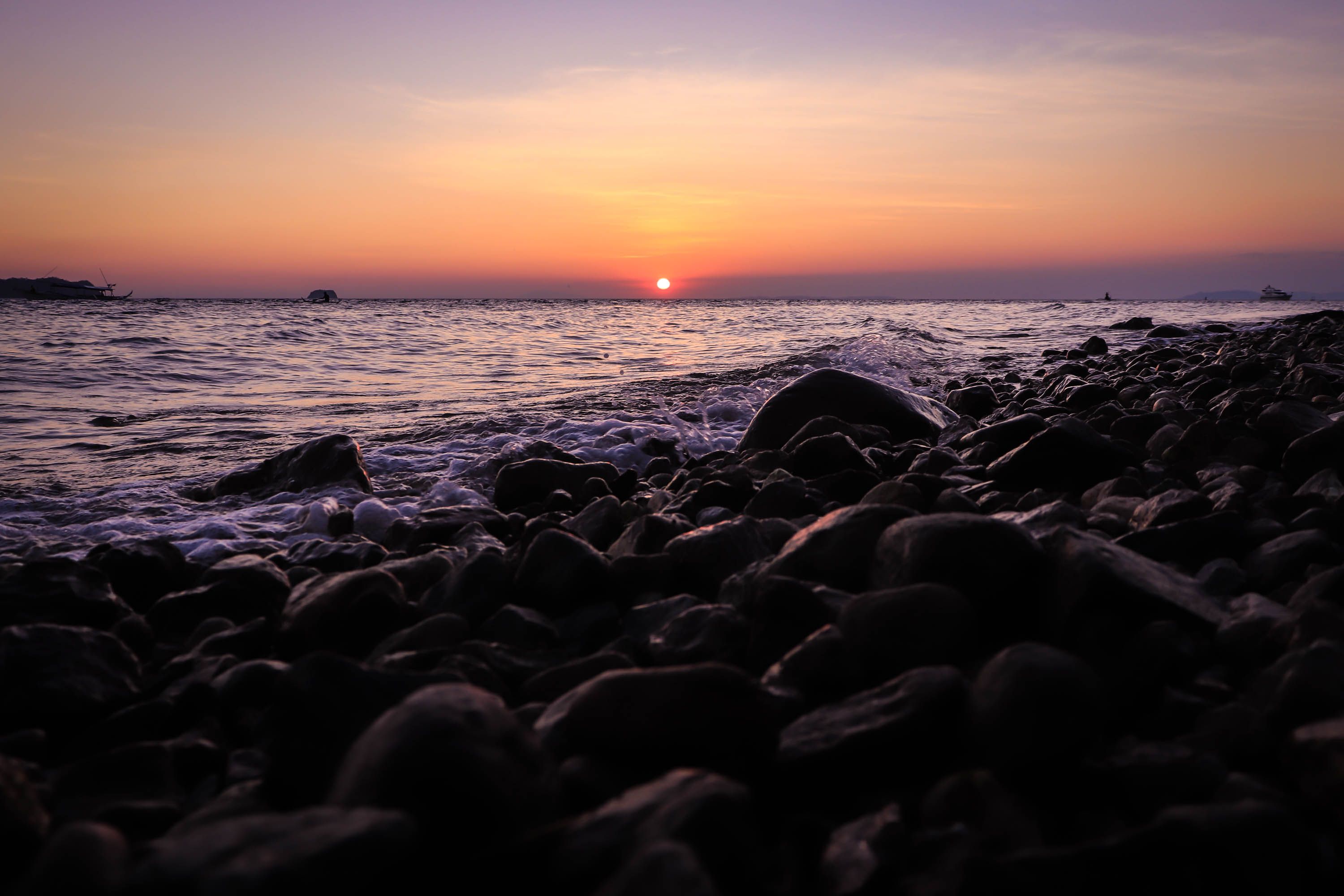 Black Rocks on Beach during Sunset · Free Stock Photo