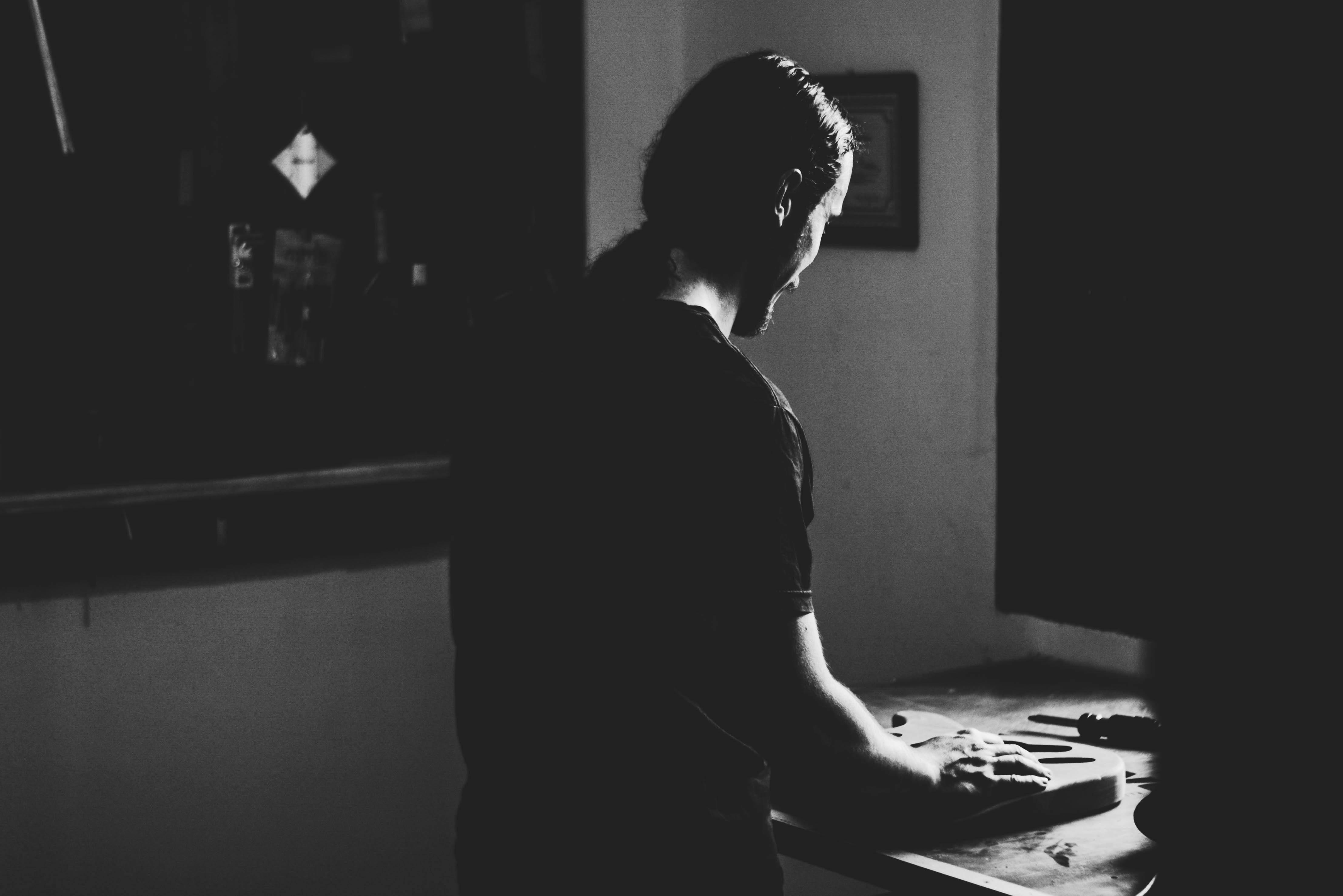 Man Standing Facing on Table · Free Stock Photo