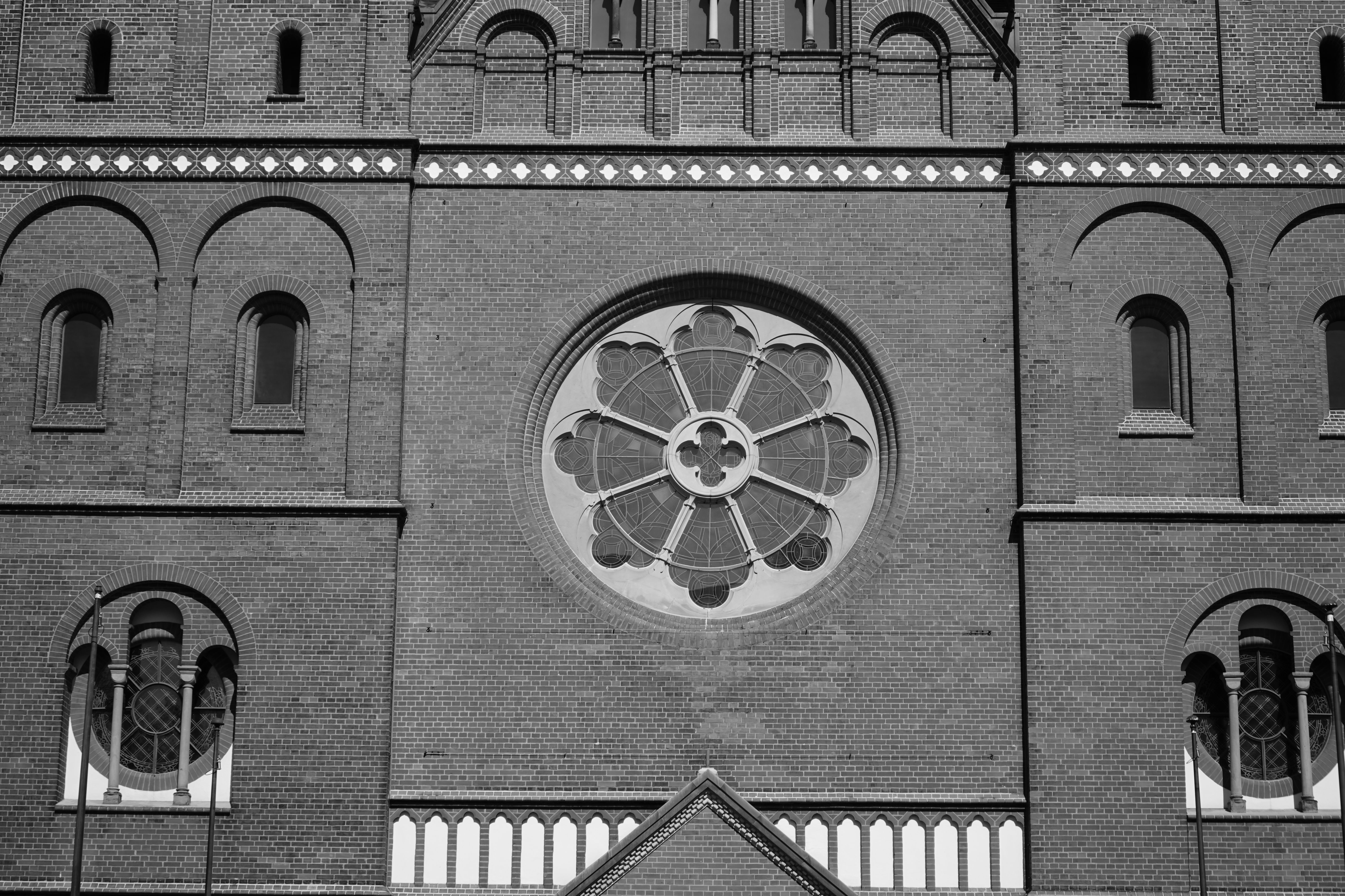 Black and White Photo of Rosette above Church Entrance · Free Stock Photo