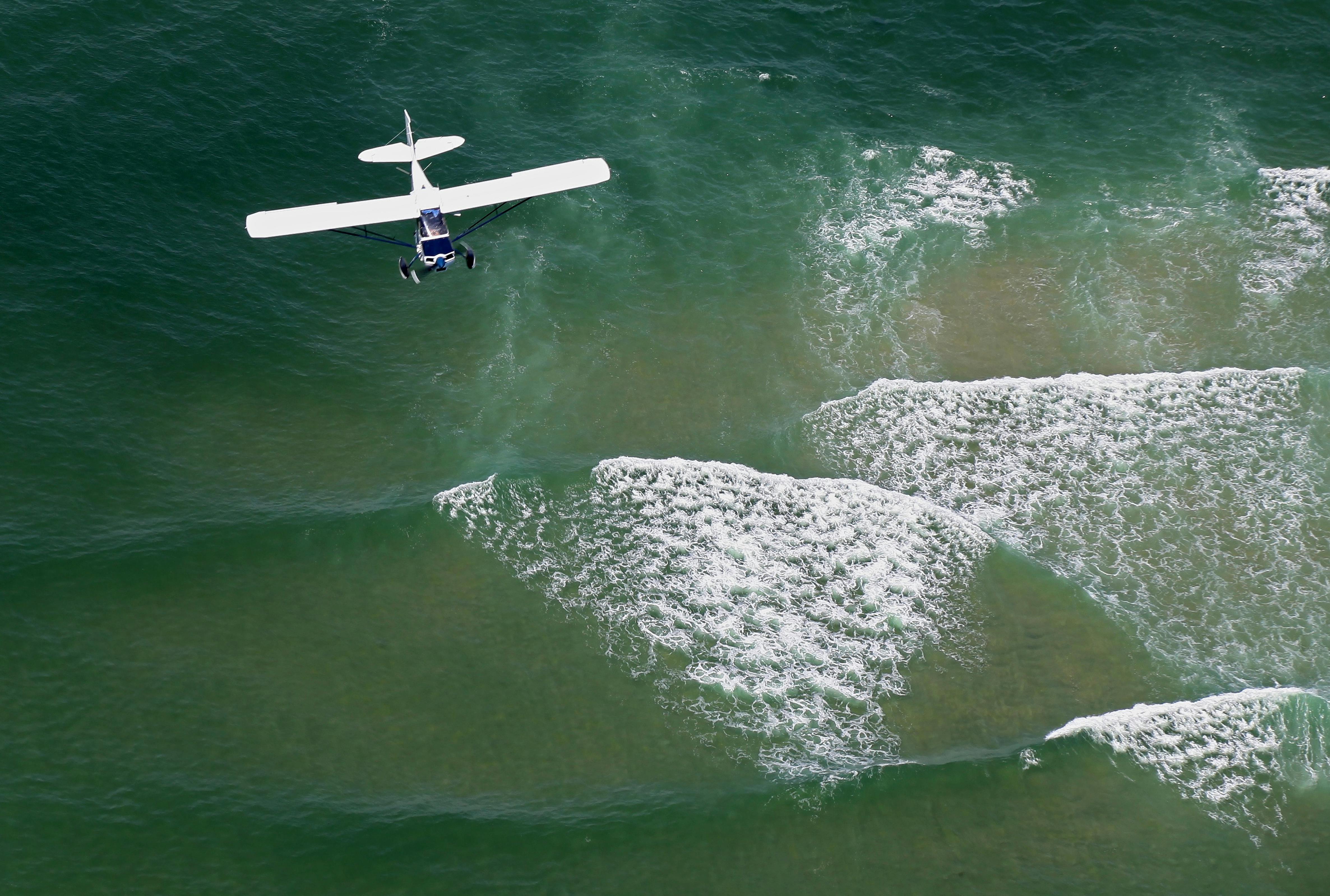 Man Floating above a Plane Wreck · Free Stock Photo