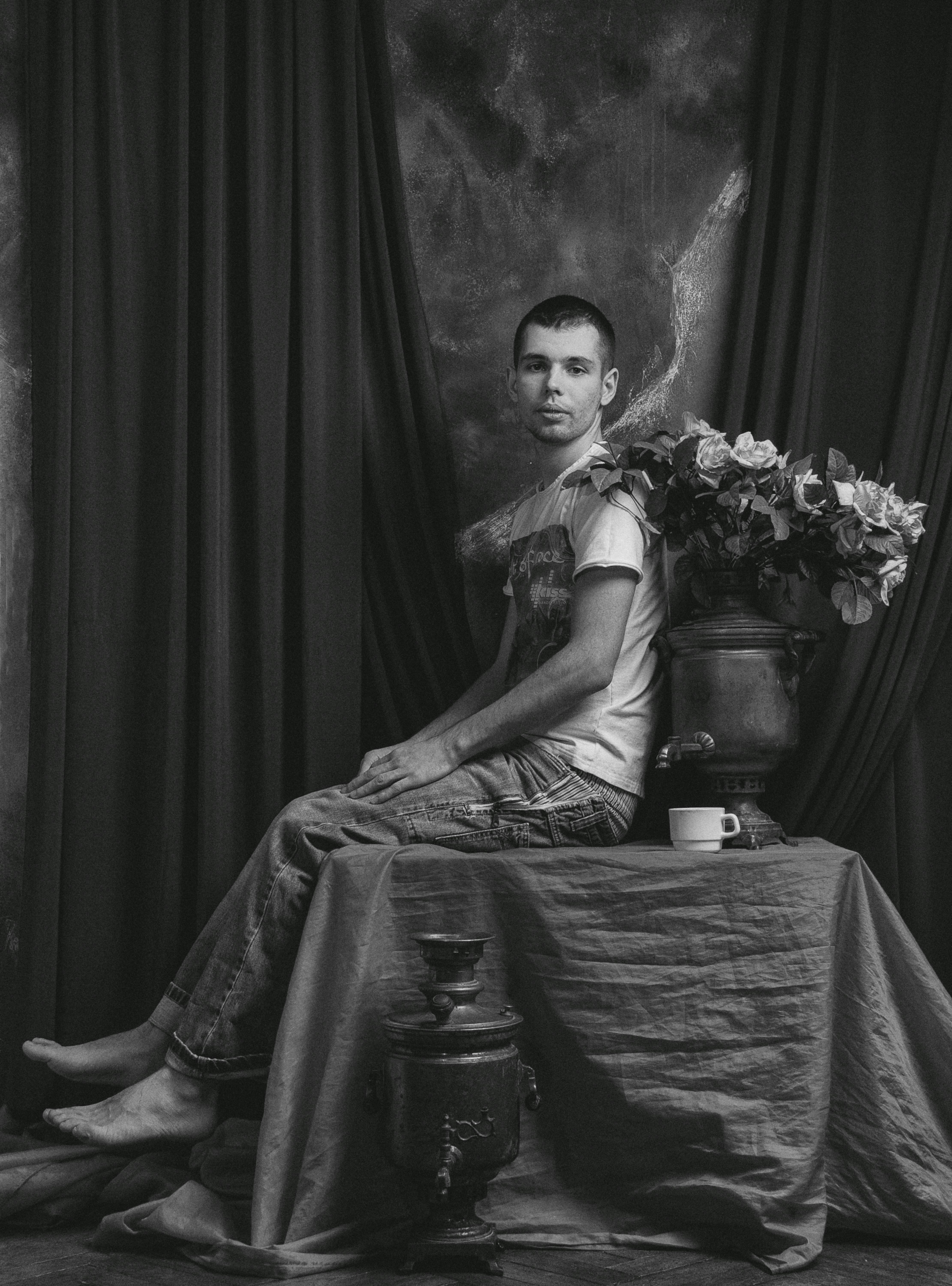 Grayscale Photo of a Man Sitting on the Table · Free Stock Photo