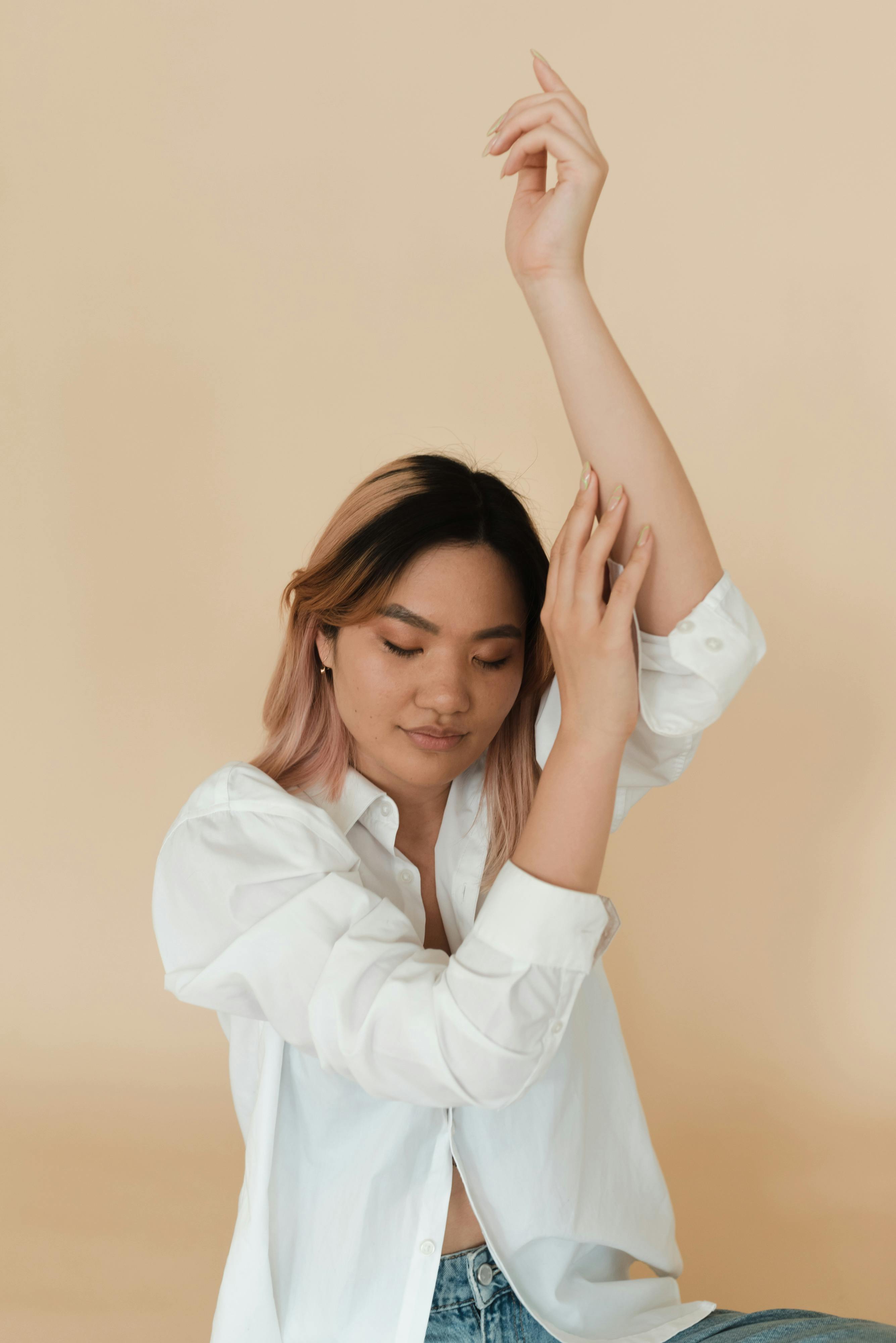 Woman Posing with Her Arm Raised · Free Stock Photo