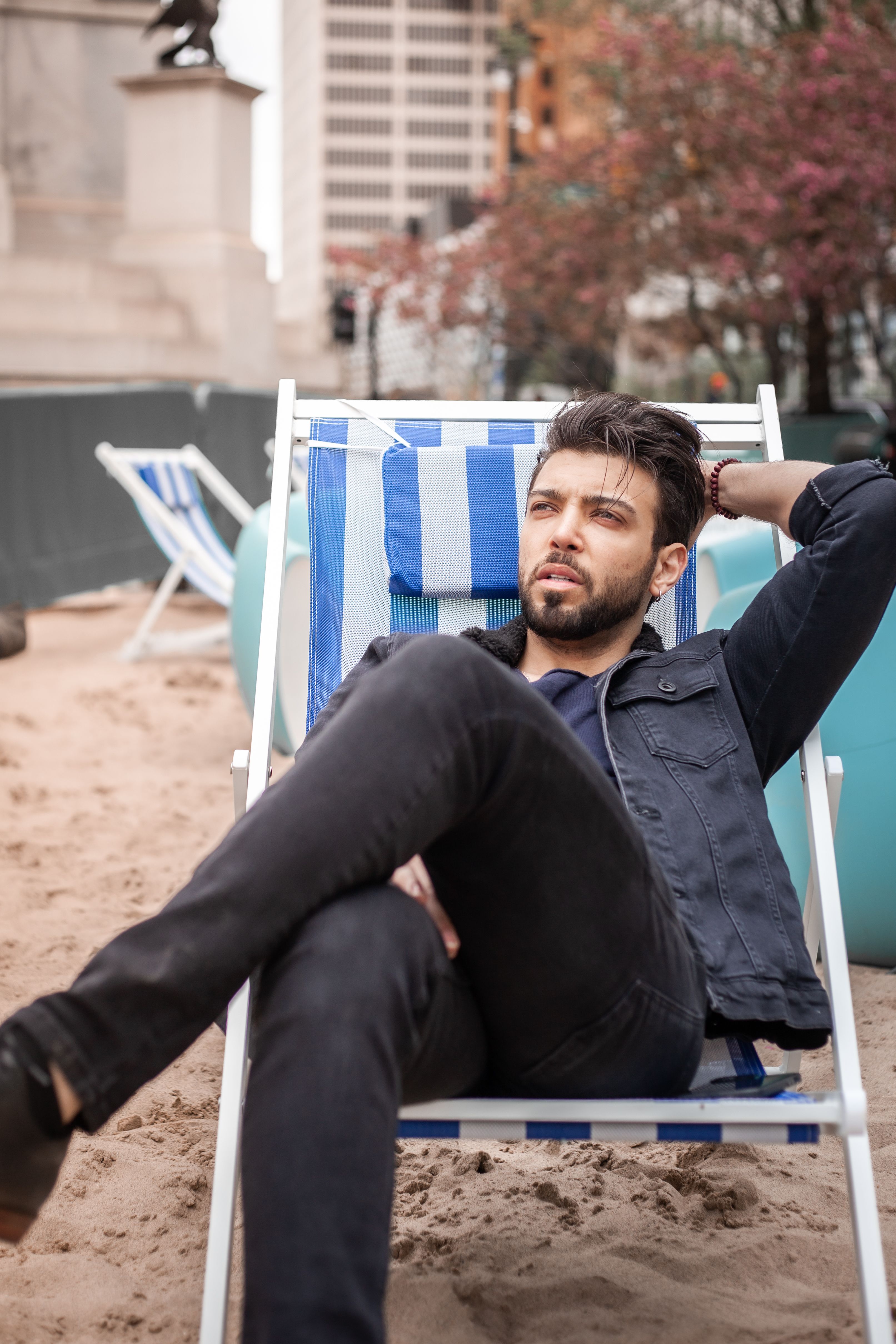Man Sitting on a Chair on a Beach · Free Stock Photo