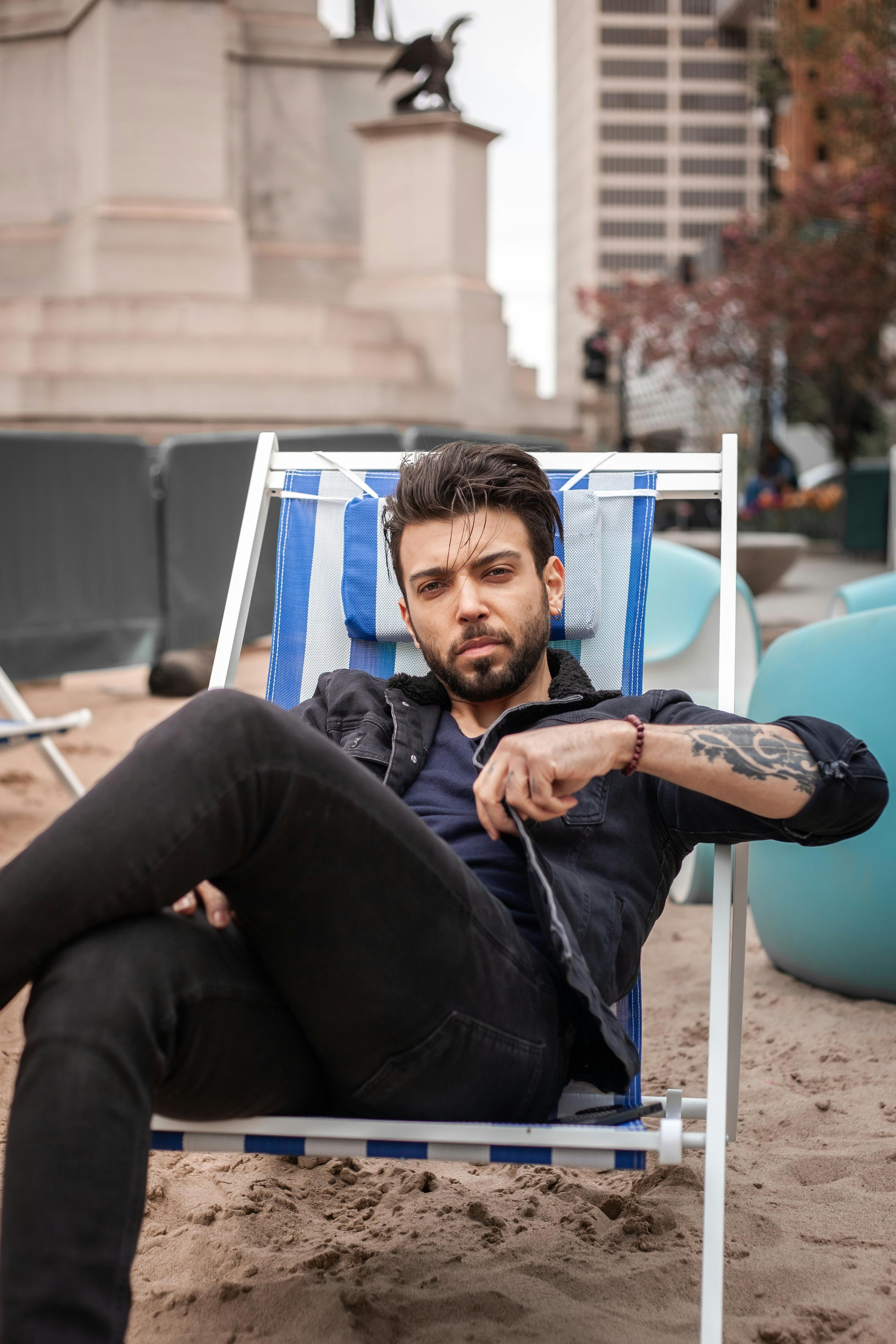 Man Sitting on a Chair on a Beach · Free Stock Photo