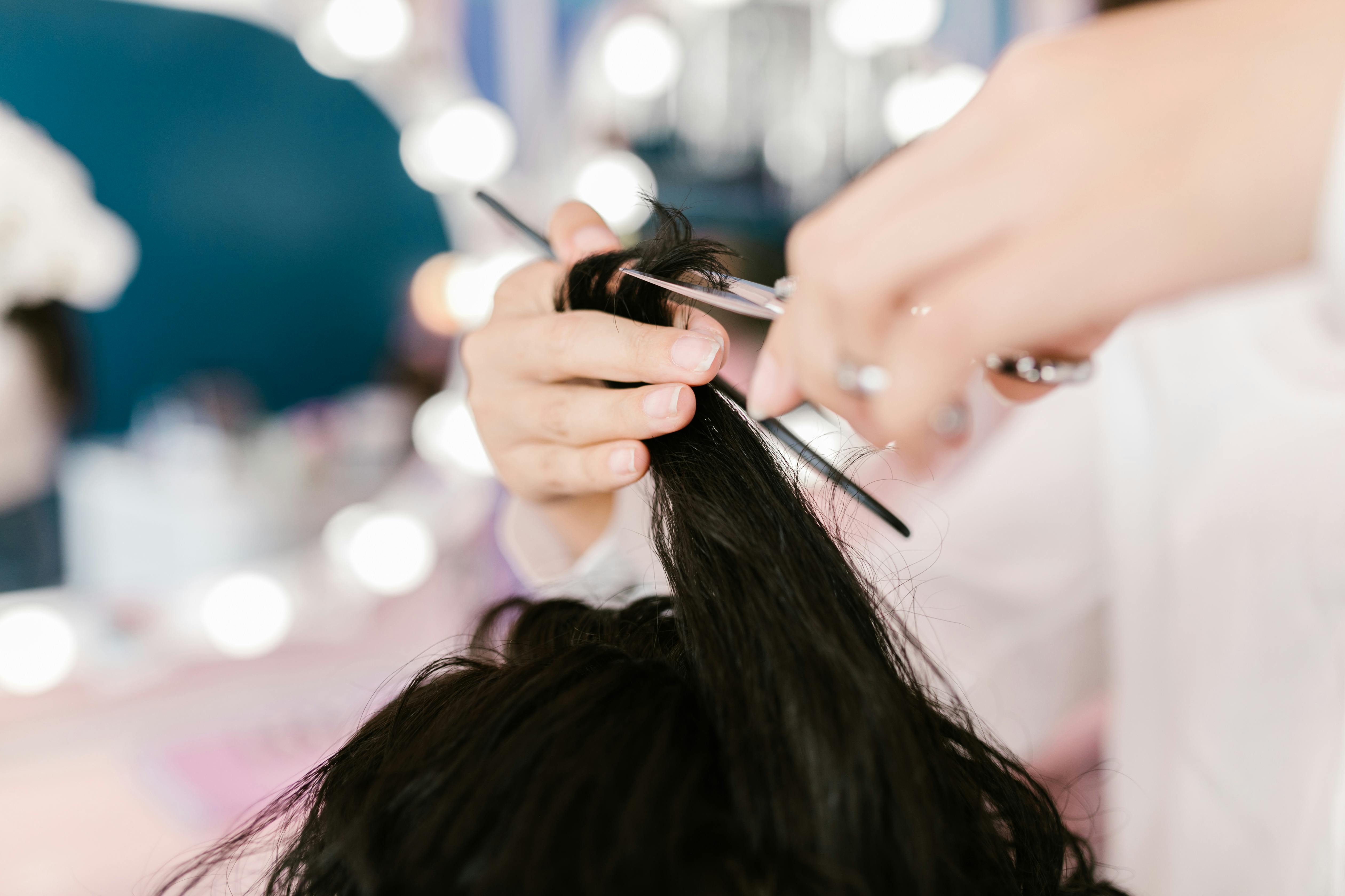 A Hand Brushing a Woman's Hair · Free Stock Photo
