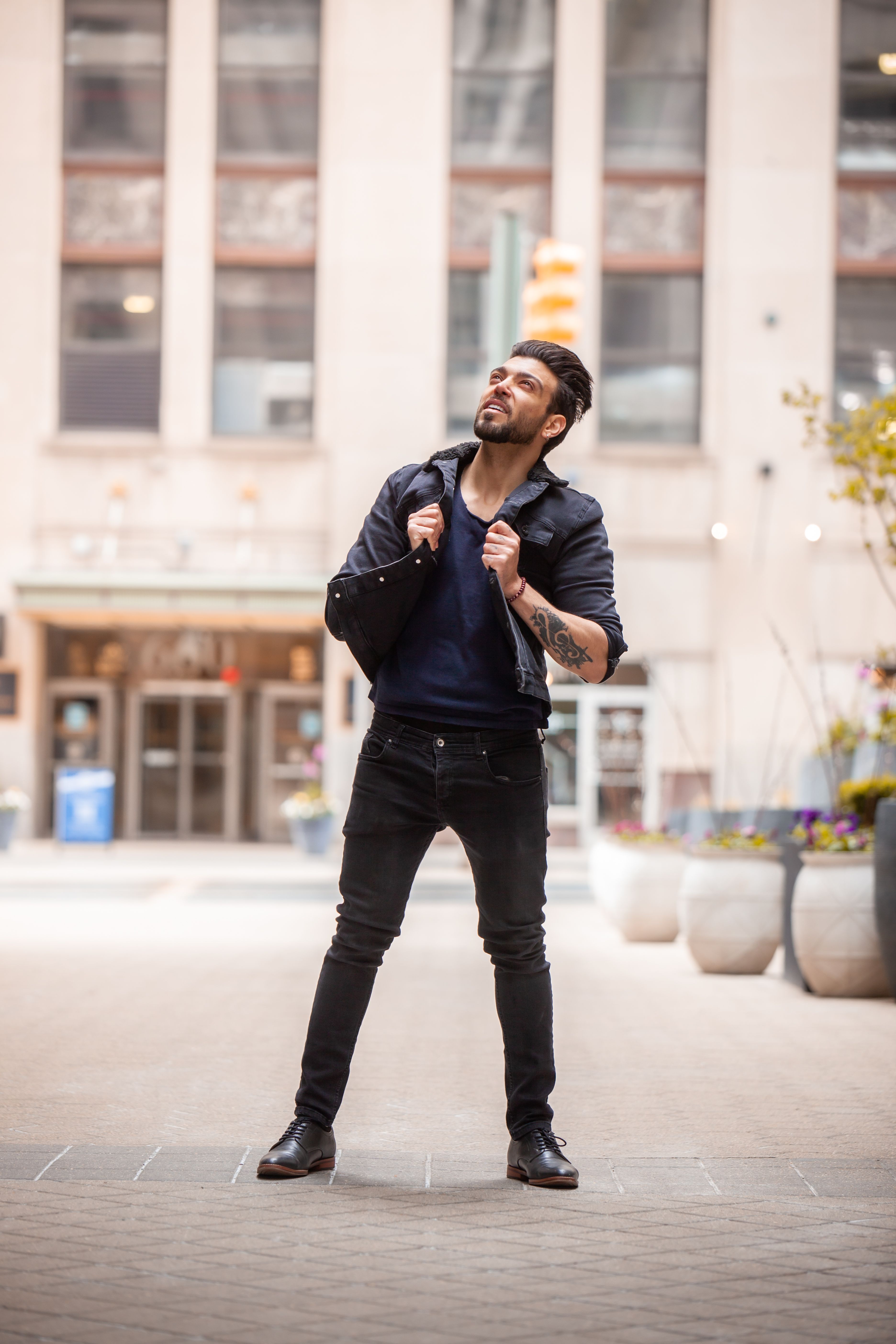 Man Standing on Pavement Holding Jacket · Free Stock Photo