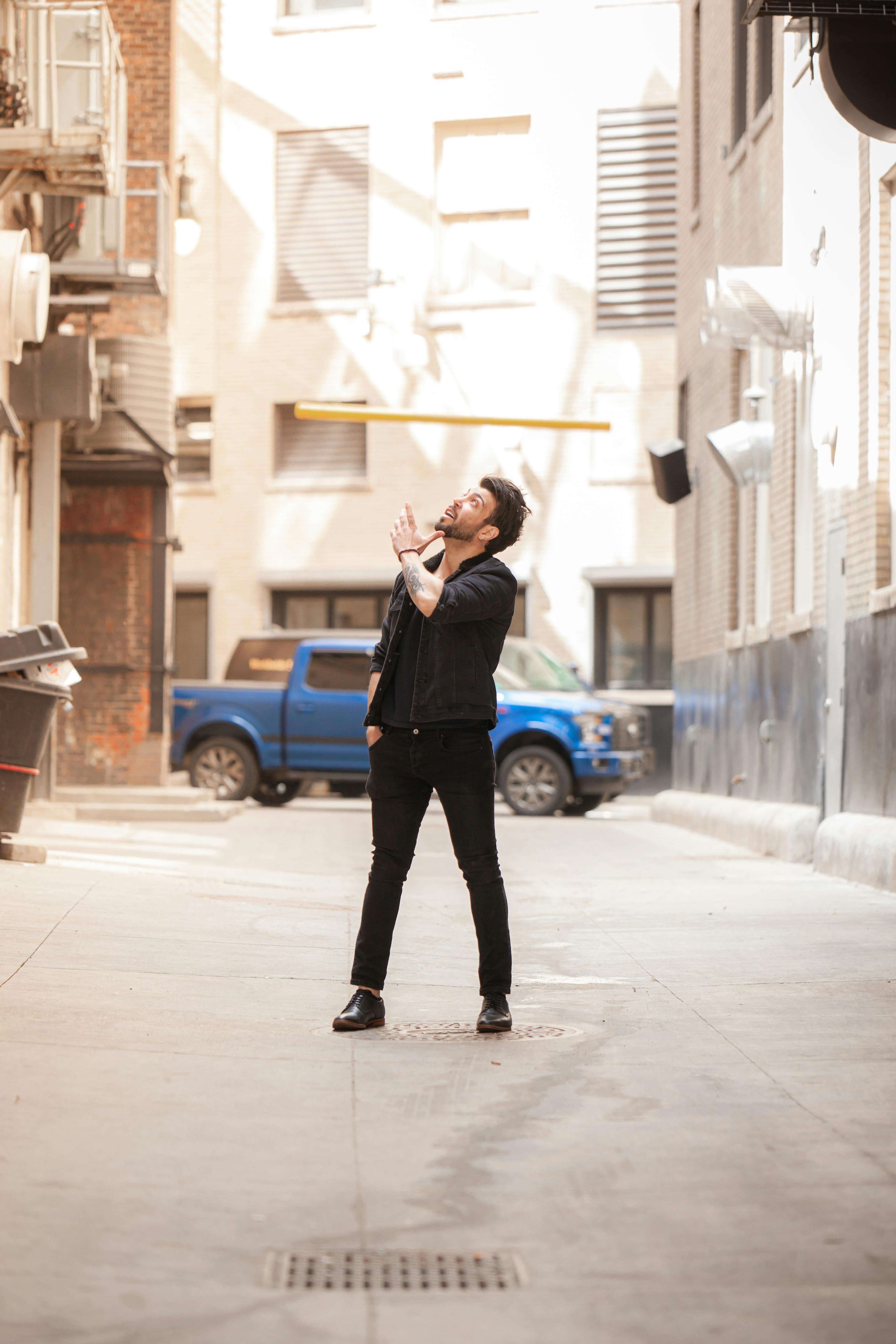 Man Standing on the Street Looking Up the Building · Free Stock Photo