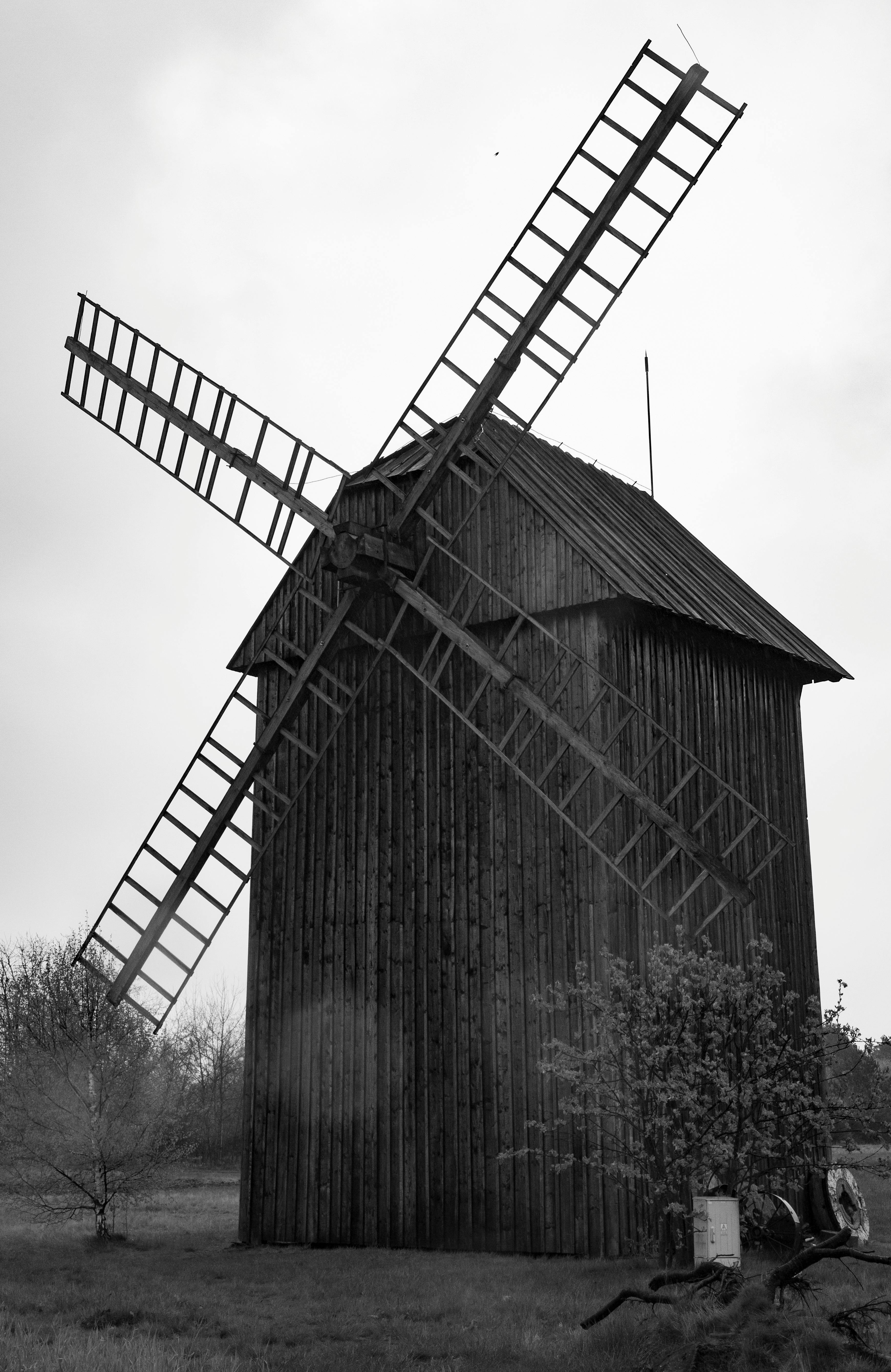 Grayscale Photography of a Wooden Windmill · Free Stock Photo