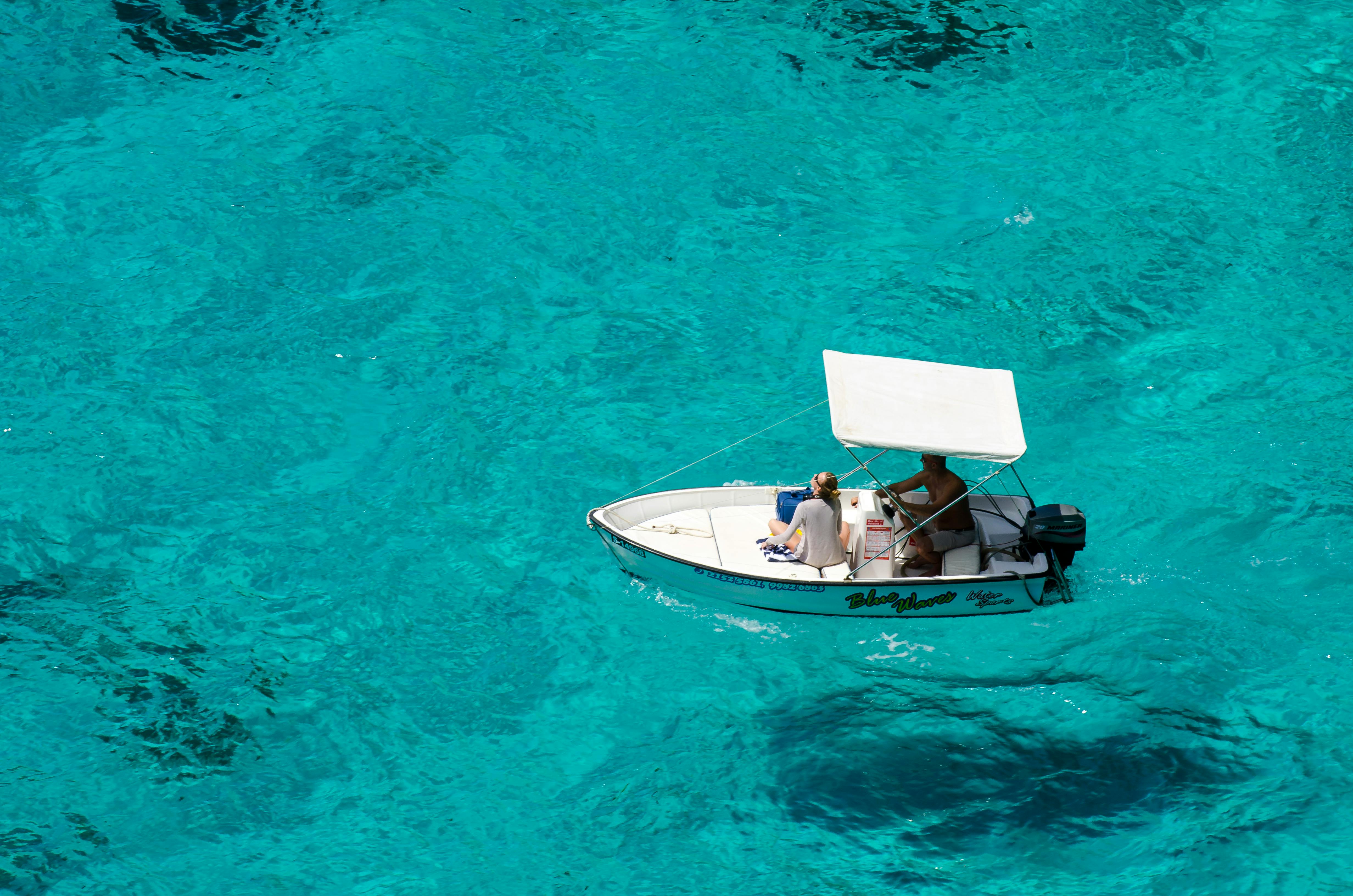 A People Riding a Boat on a River · Free Stock Photo