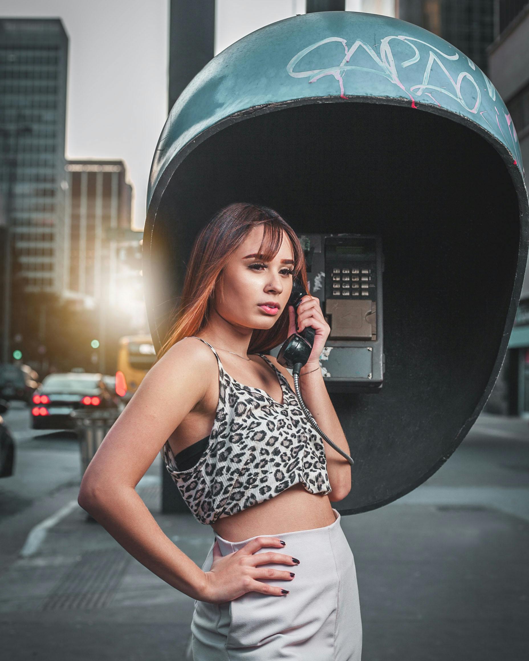 A Woman Calling using a Payphone · Free Stock Photo