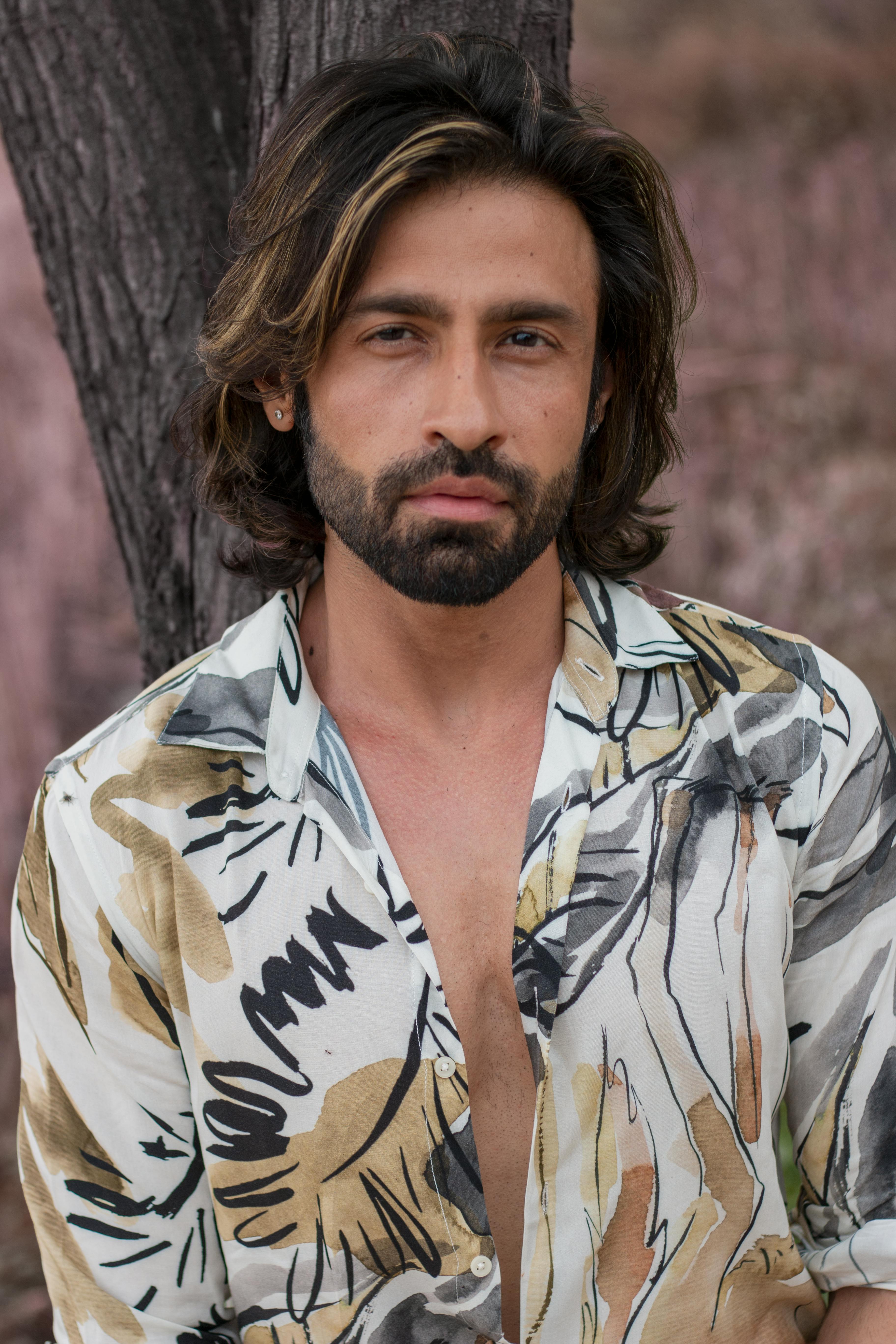 A Bearded Man Leaning on a Tree · Free Stock Photo