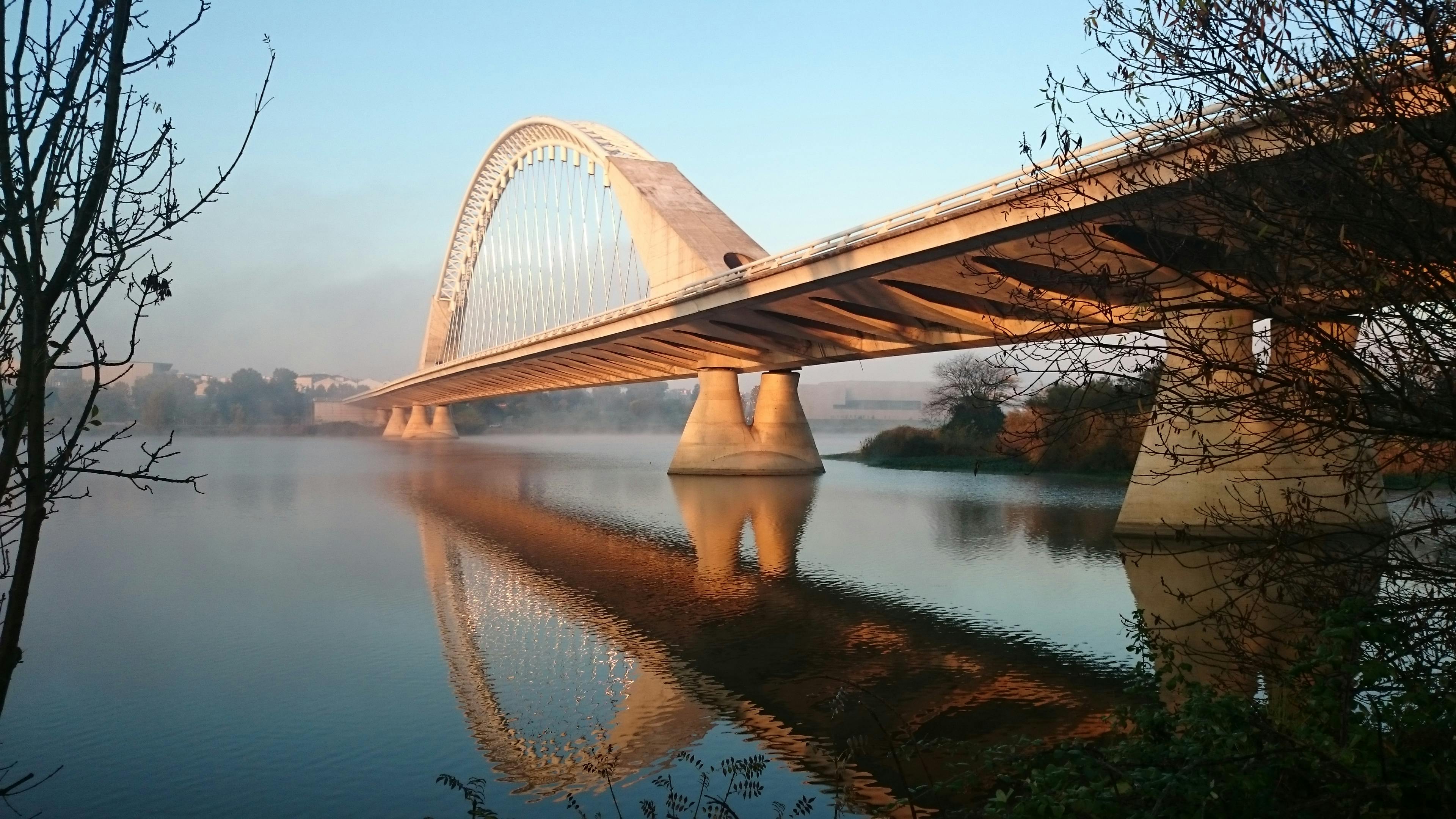 Grey Concrete Bridge Above Water Under Blue Sky · Free Stock Photo