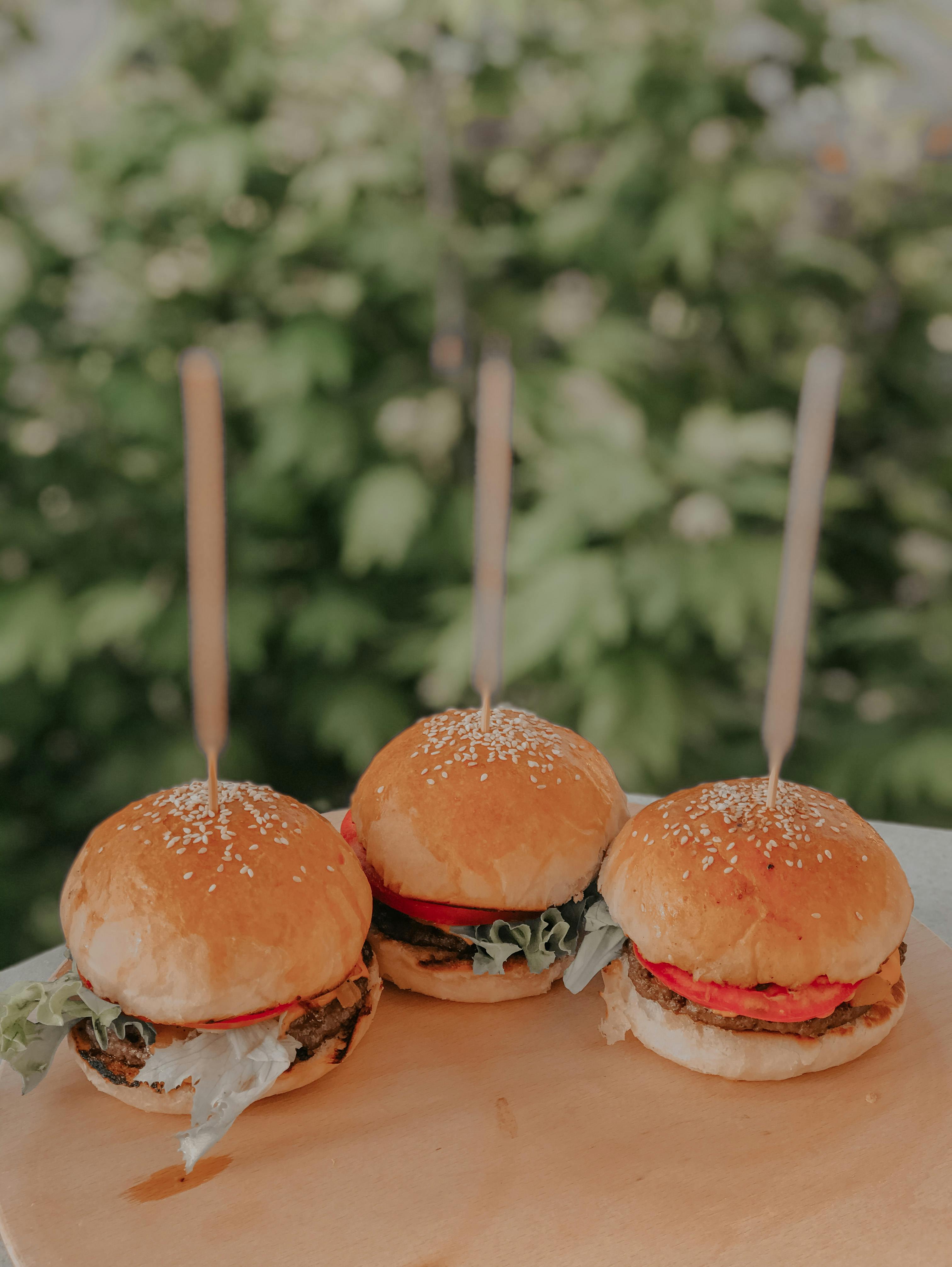 Burgers on a Wooden Table · Free Stock Photo