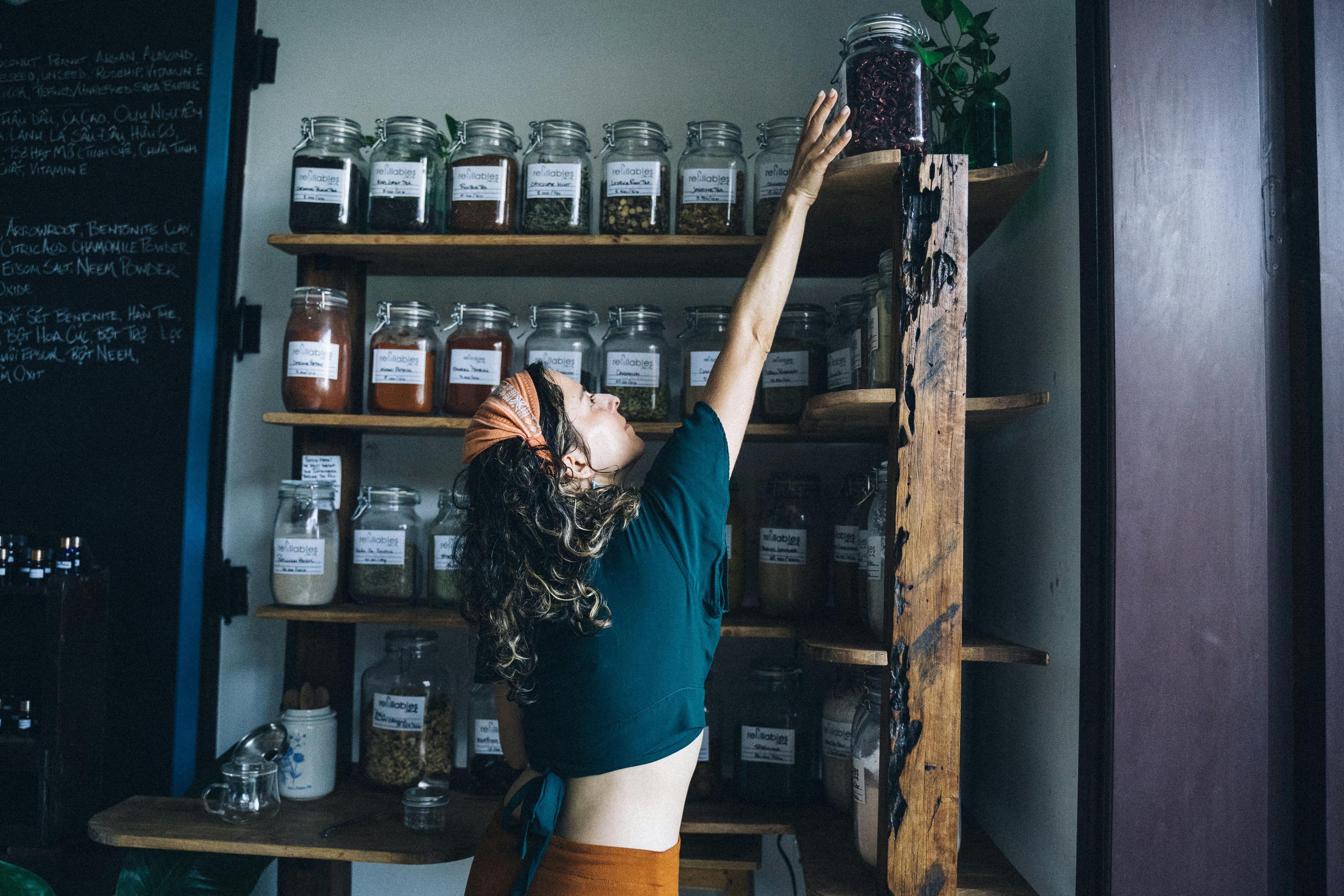 Woman Reaching at the Top Shelf · Free Stock Photo