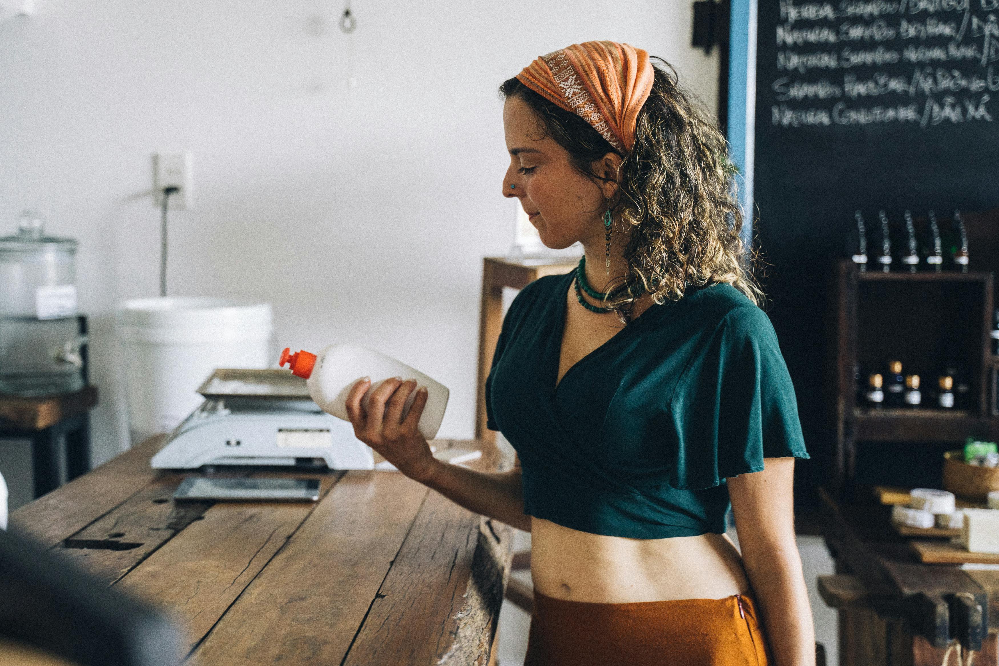 Woman in Blue Crop Top Standing Near Wooden Table · Free Stock Photo