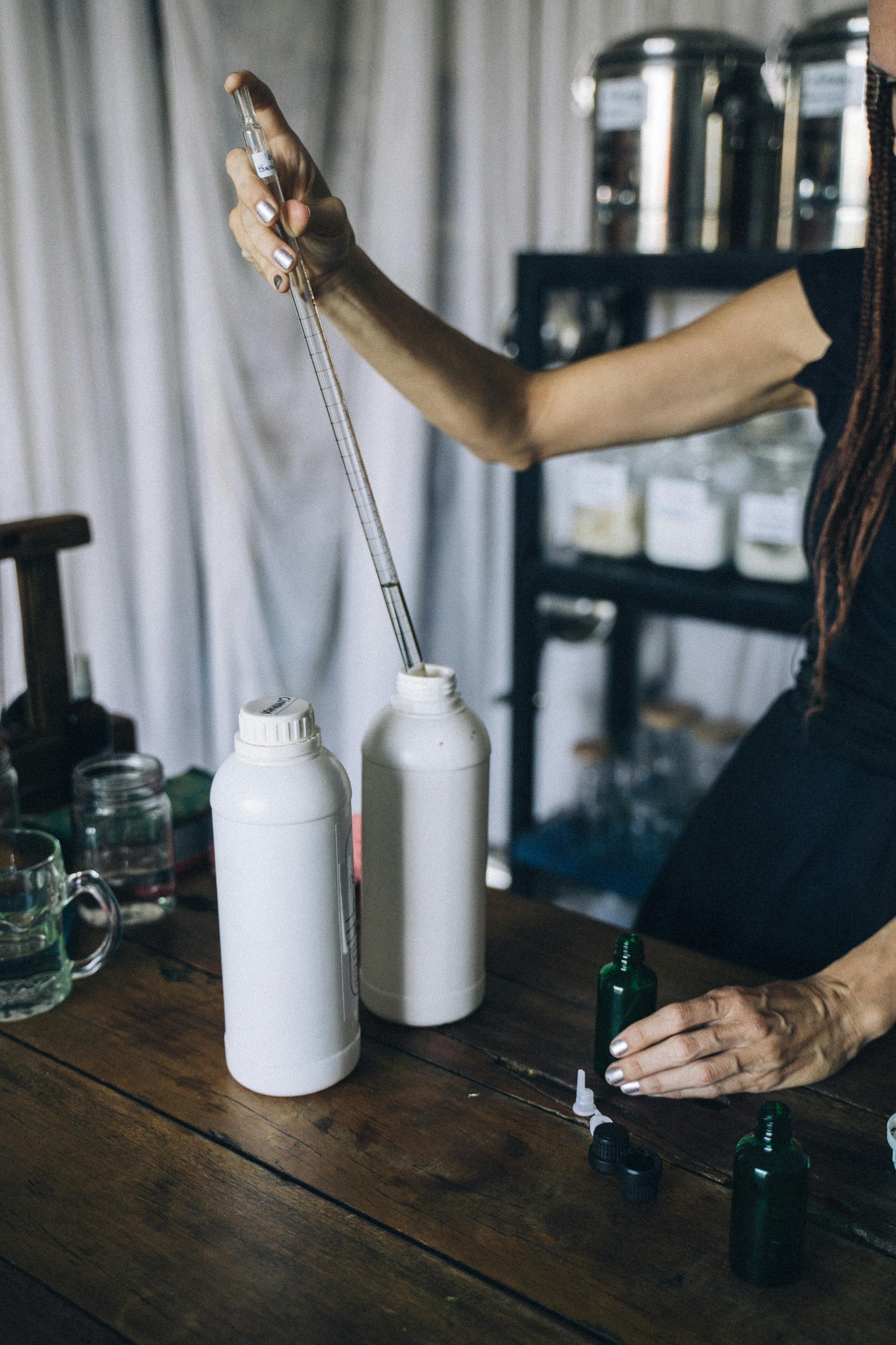 A Person Holding a Dropper · Free Stock Photo