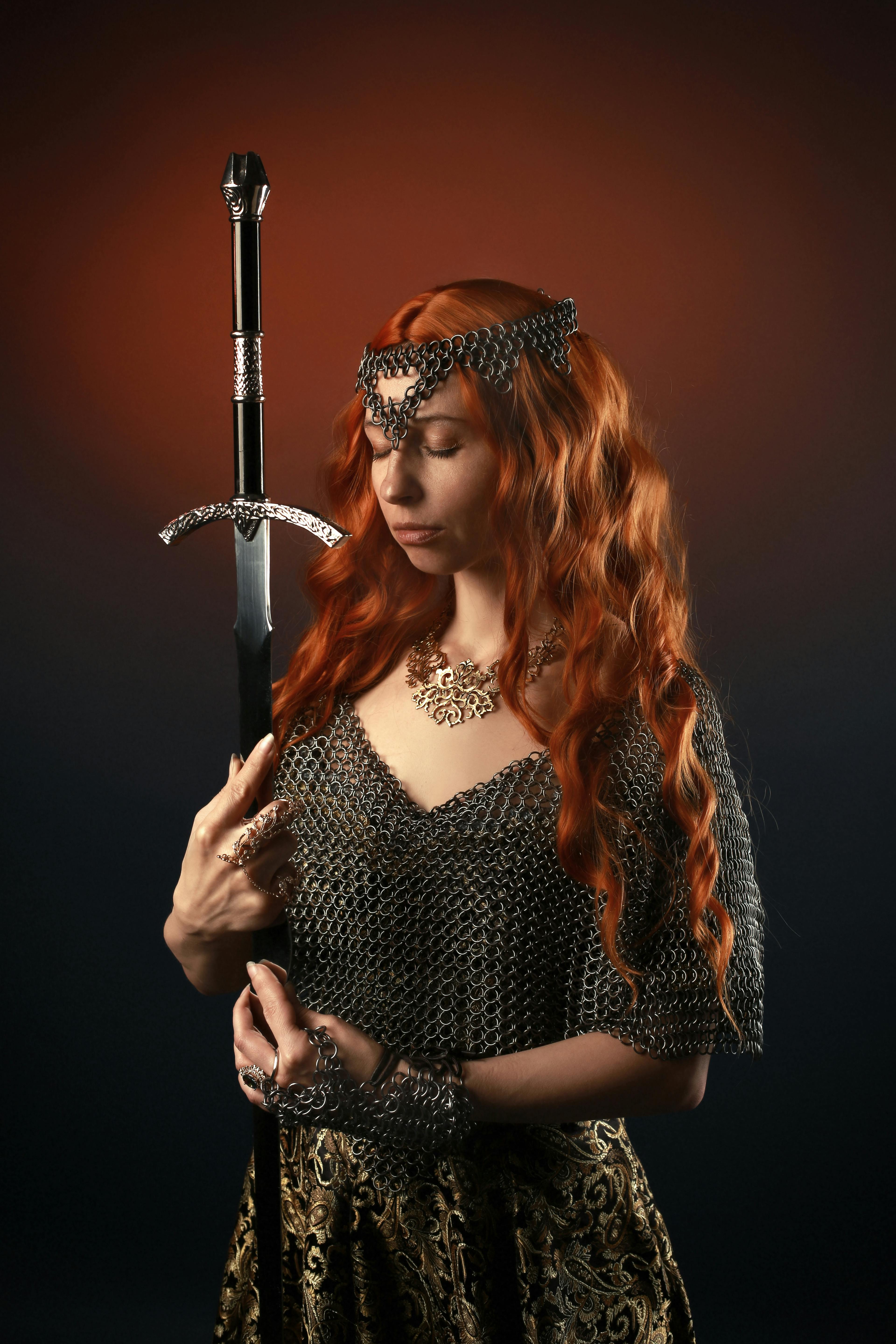 Young woman in chainmail armor with sword · Free Stock Photo