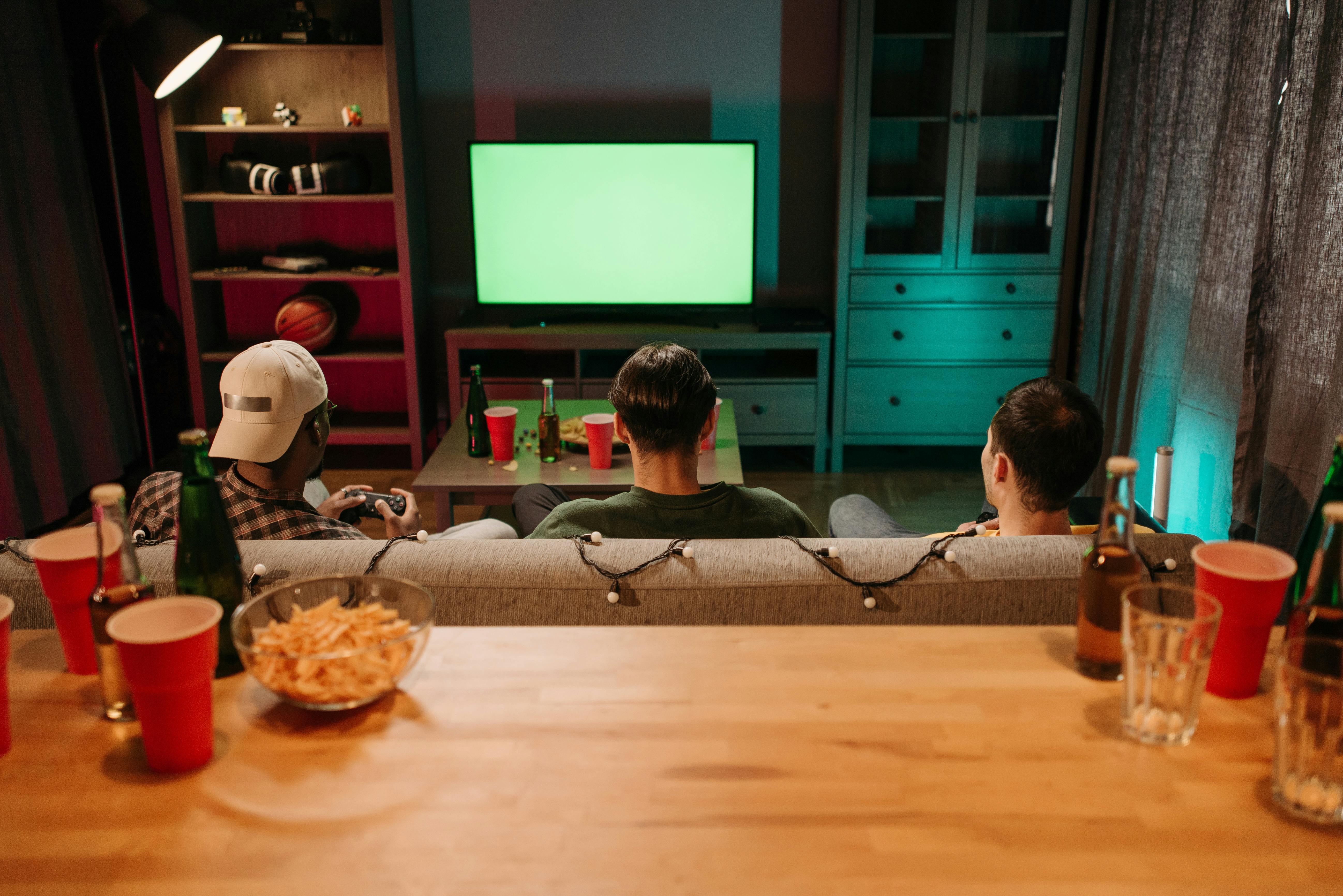 Gamers Sitting on a Sofa · Free Stock Photo