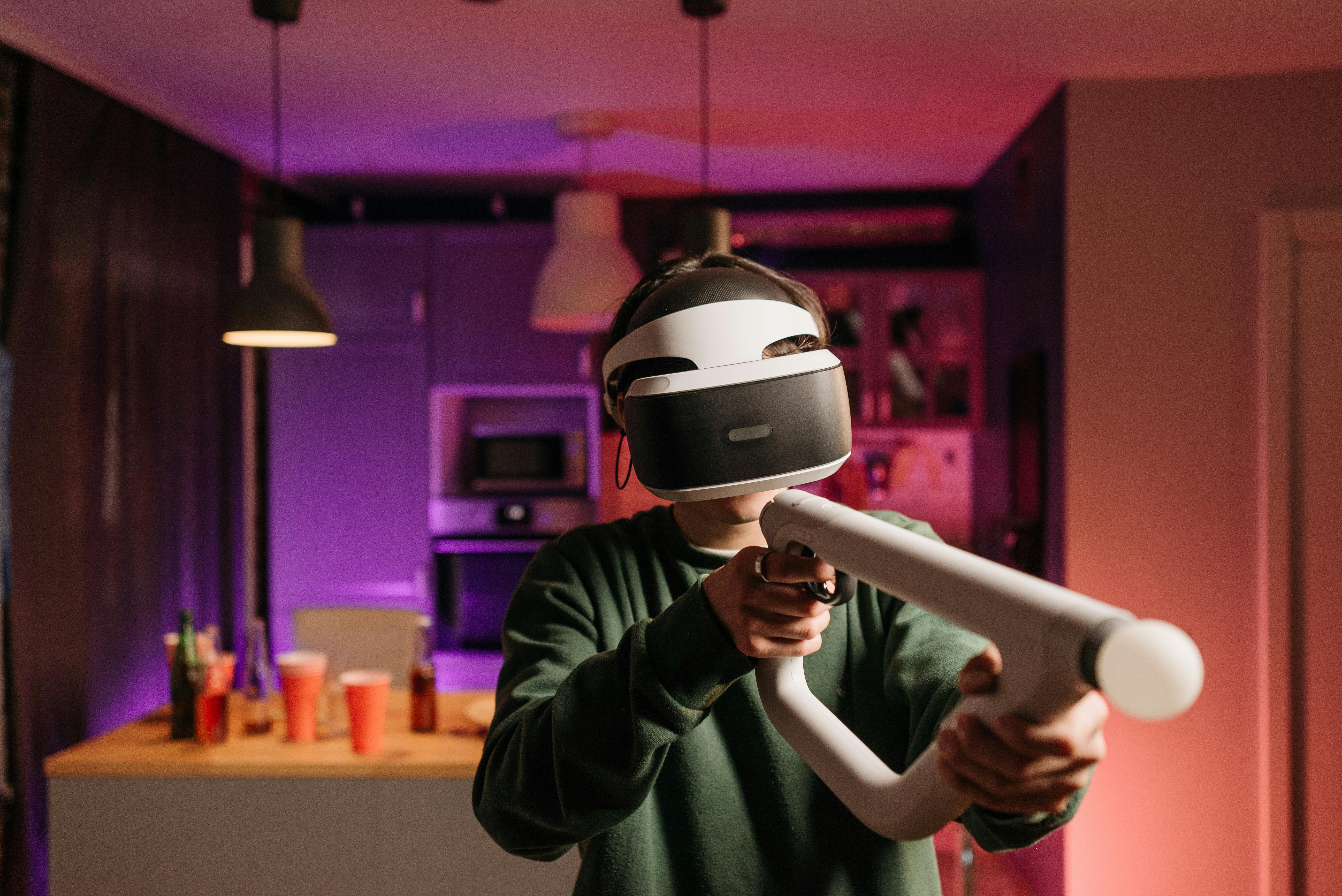 A Person in Green Long Sleeves Playing with VR Controller · Free Stock ...