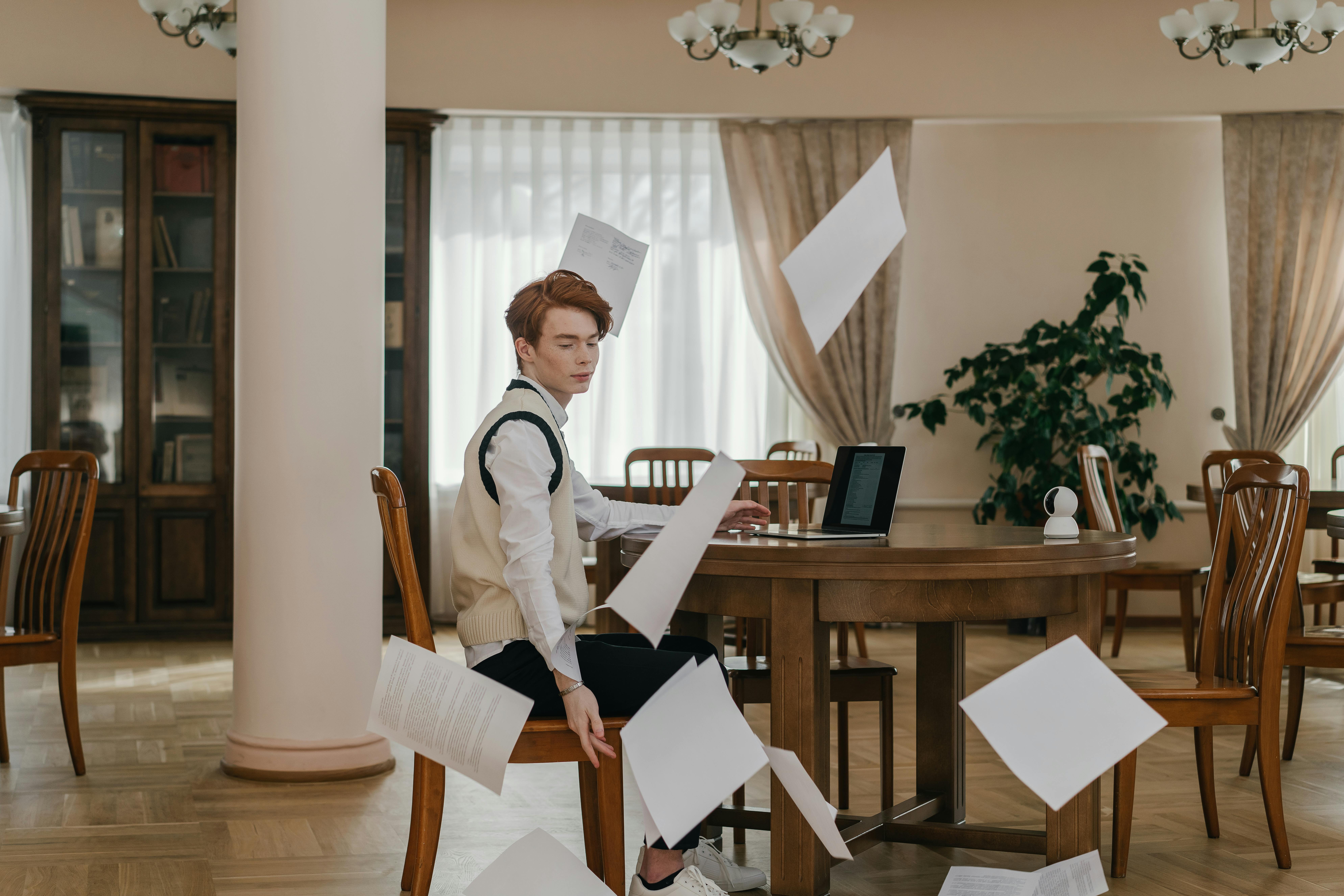 A Man Throwing Papers on the Ground · Free Stock Photo