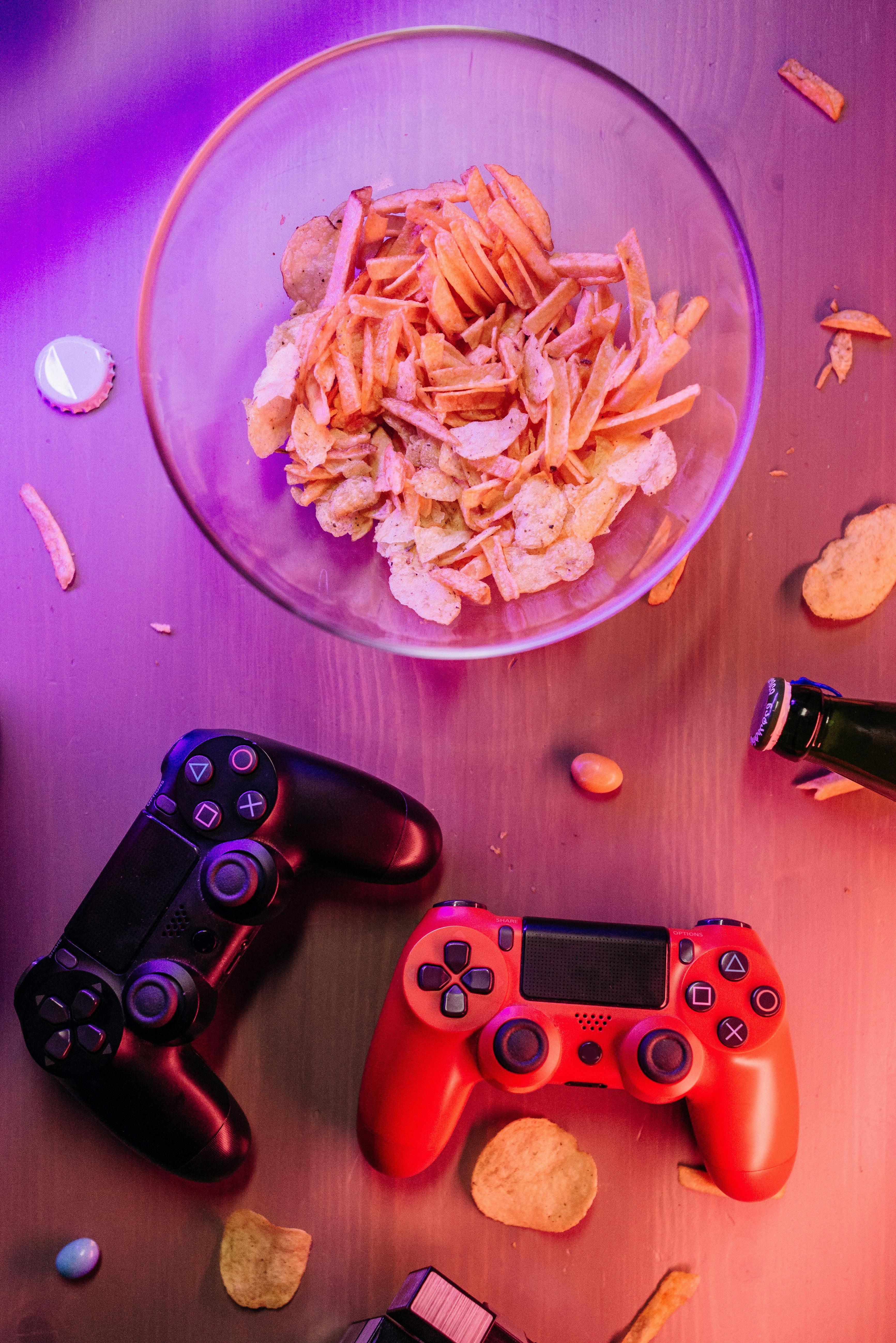Game Controllers Beside a Bowl of Chips · Free Stock Photo