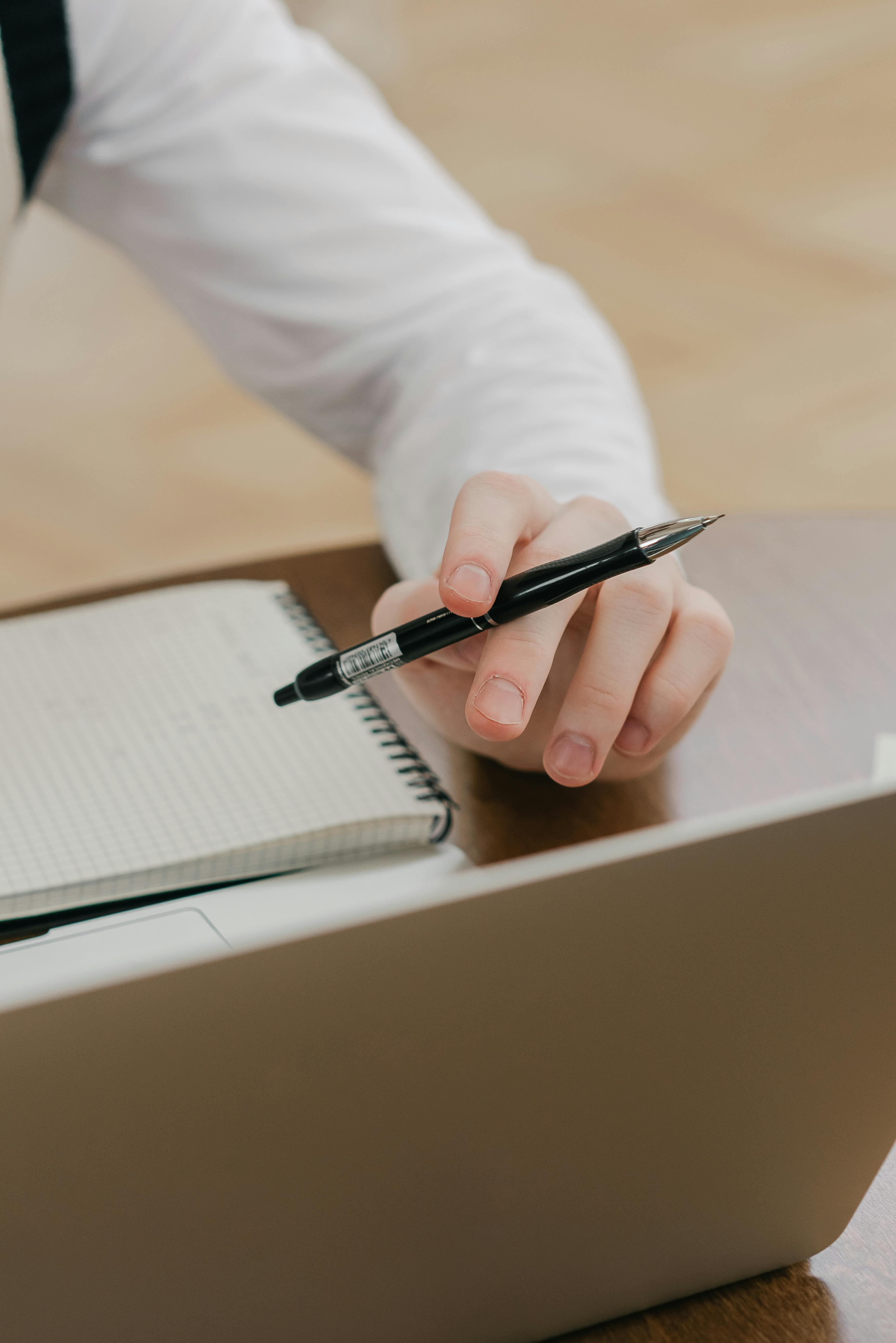 A Person Holding a Pen · Free Stock Photo