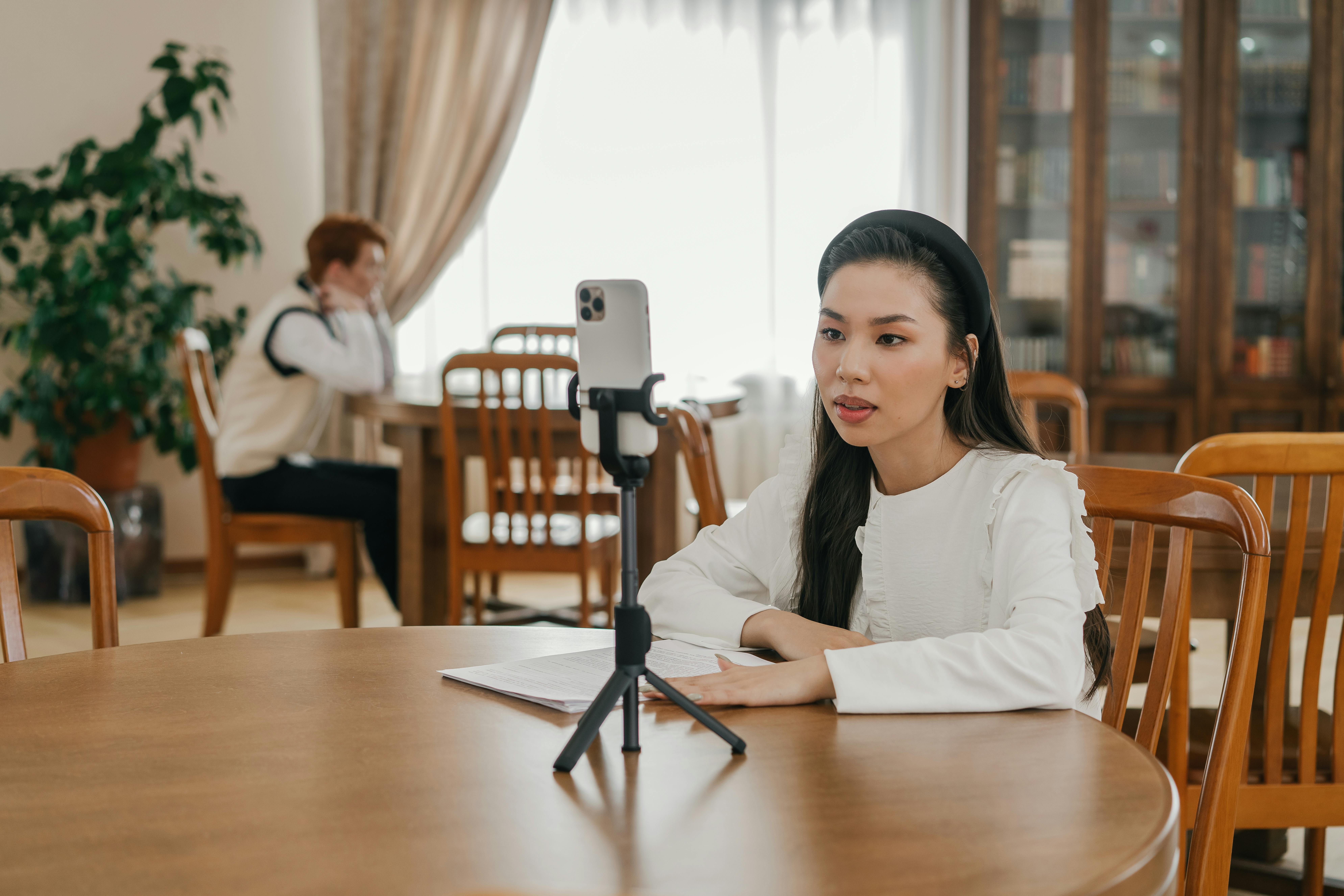 A Woman Standing on a Yoga Mat while Vlogging · Free Stock Photo