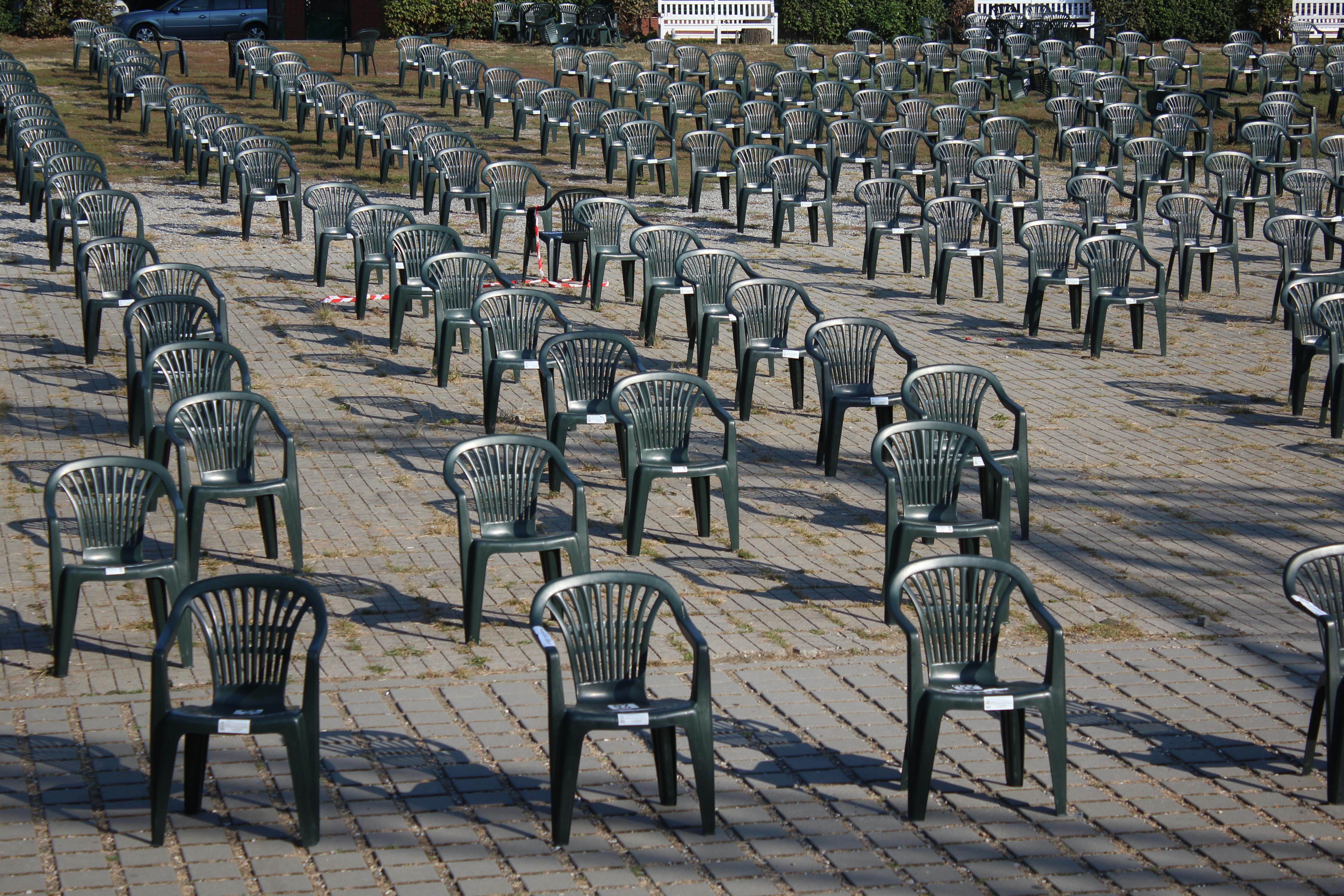 Rows of Plastic Chairs on Concrete Pavement · Free Stock Photo