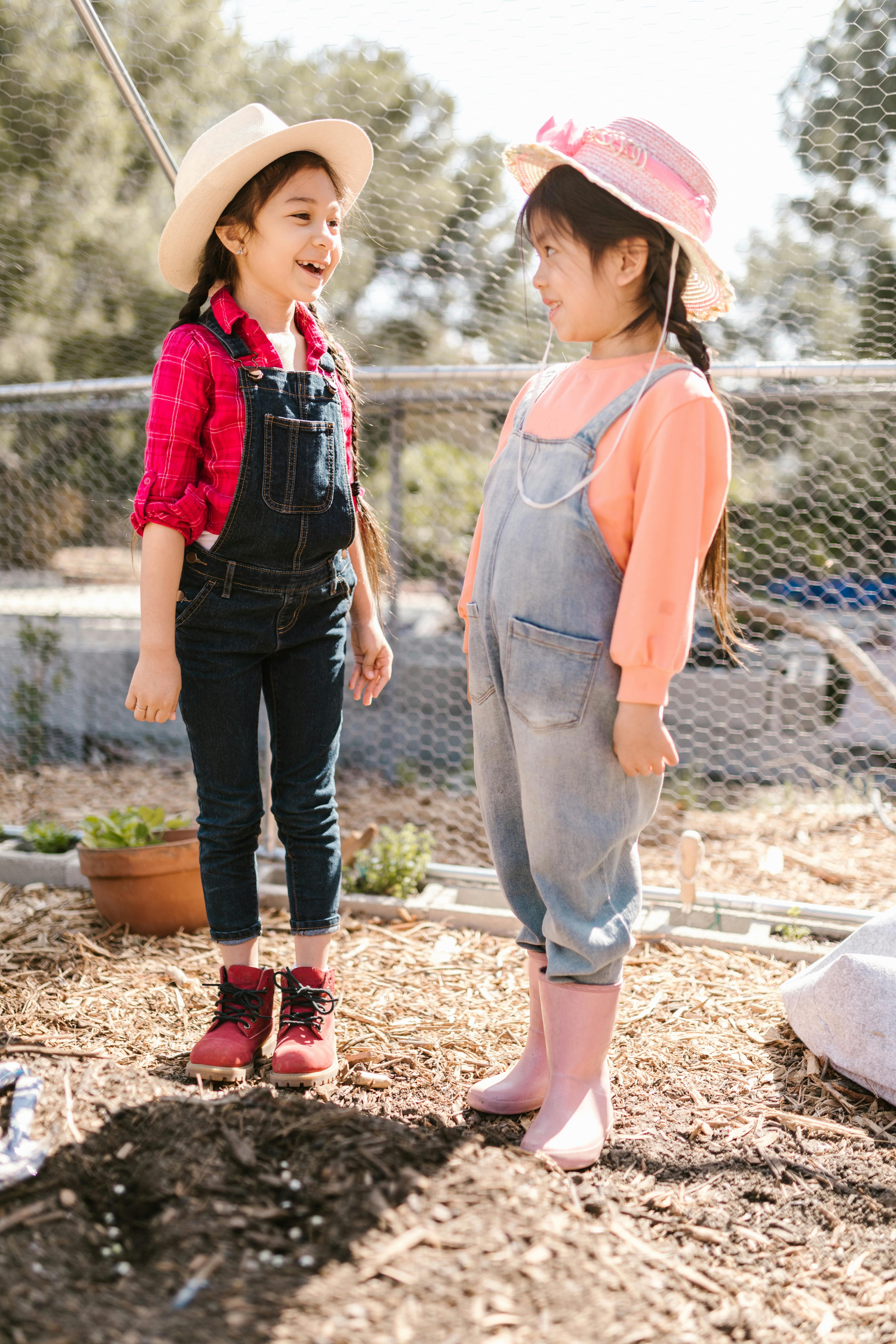 Girls in Jean Overalls Standing on Farm · Free Stock Photo