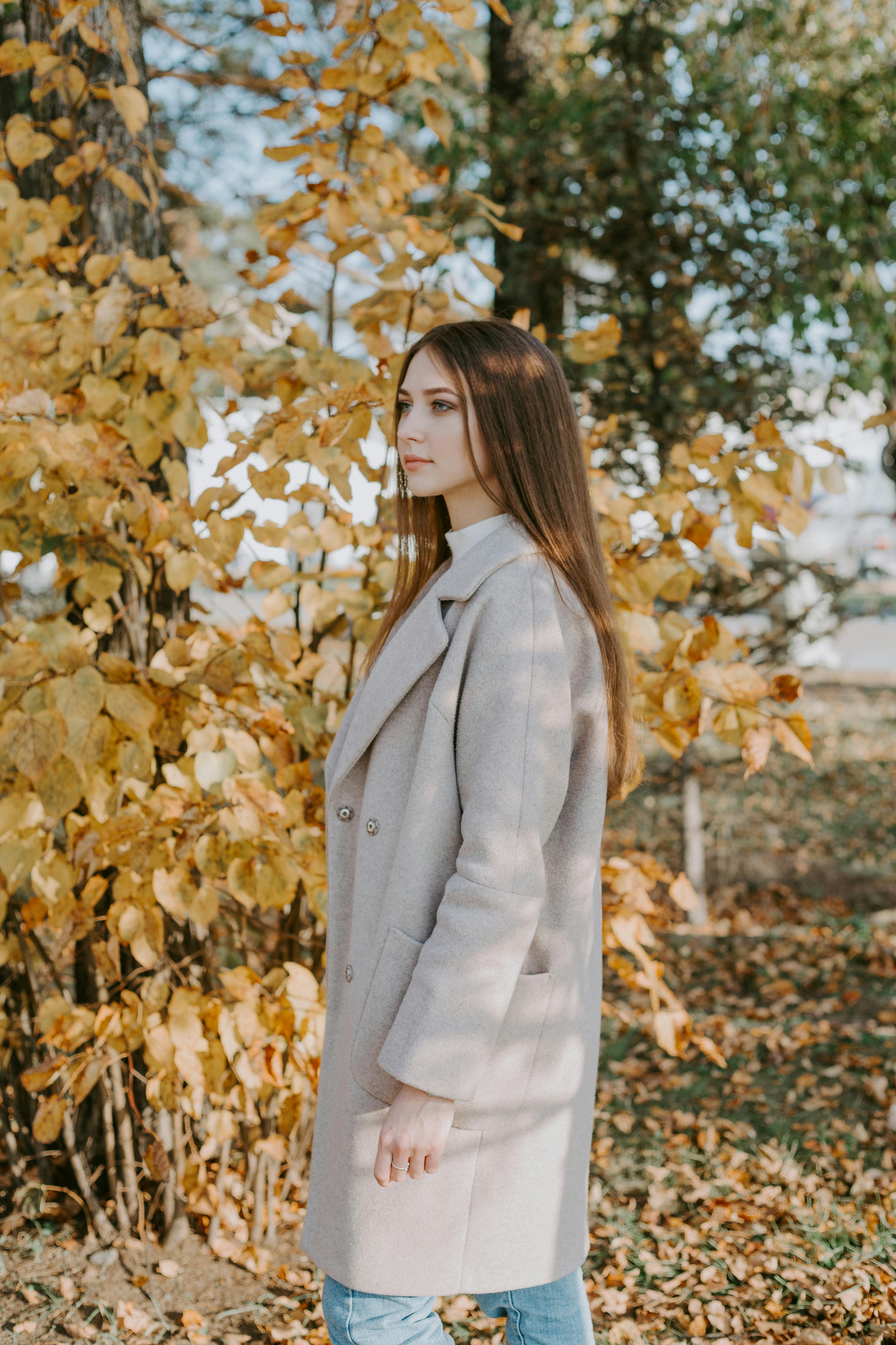 A Woman Standing outdoors Wearing a Formal Coat · Free Stock Photo