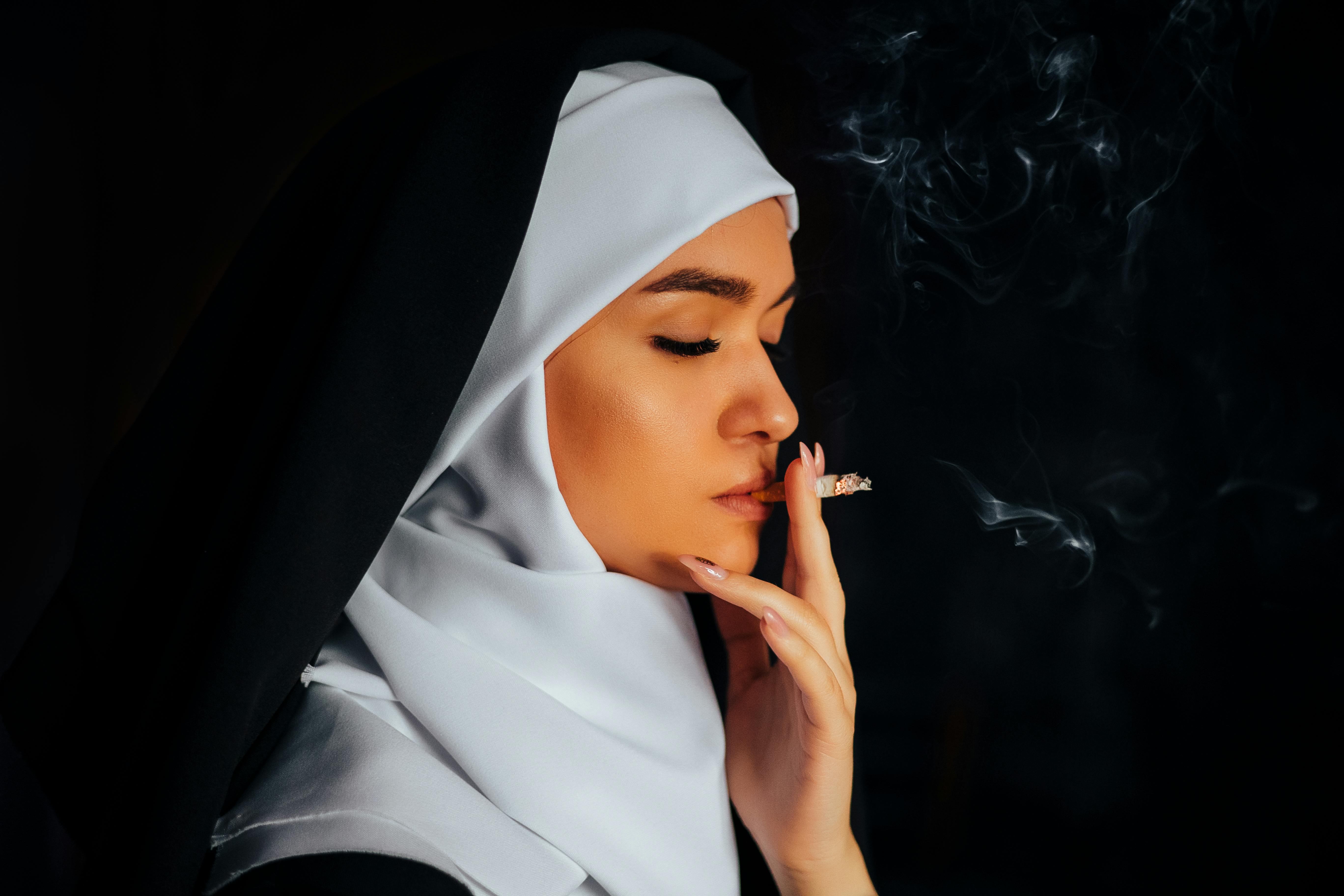 A Woman Lighting a Cigarette · Free Stock Photo