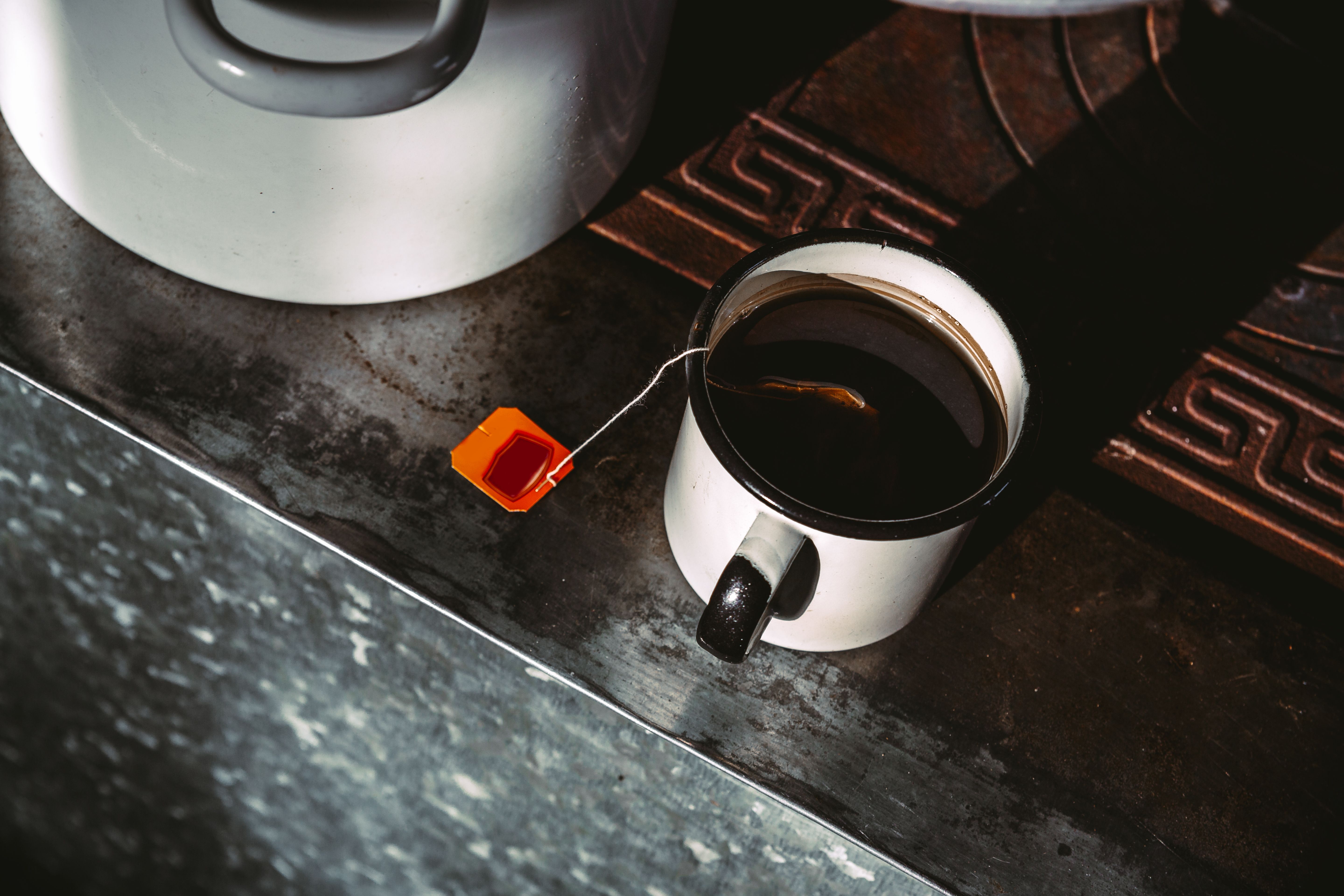 A Coffee Mug on an Open Book · Free Stock Photo