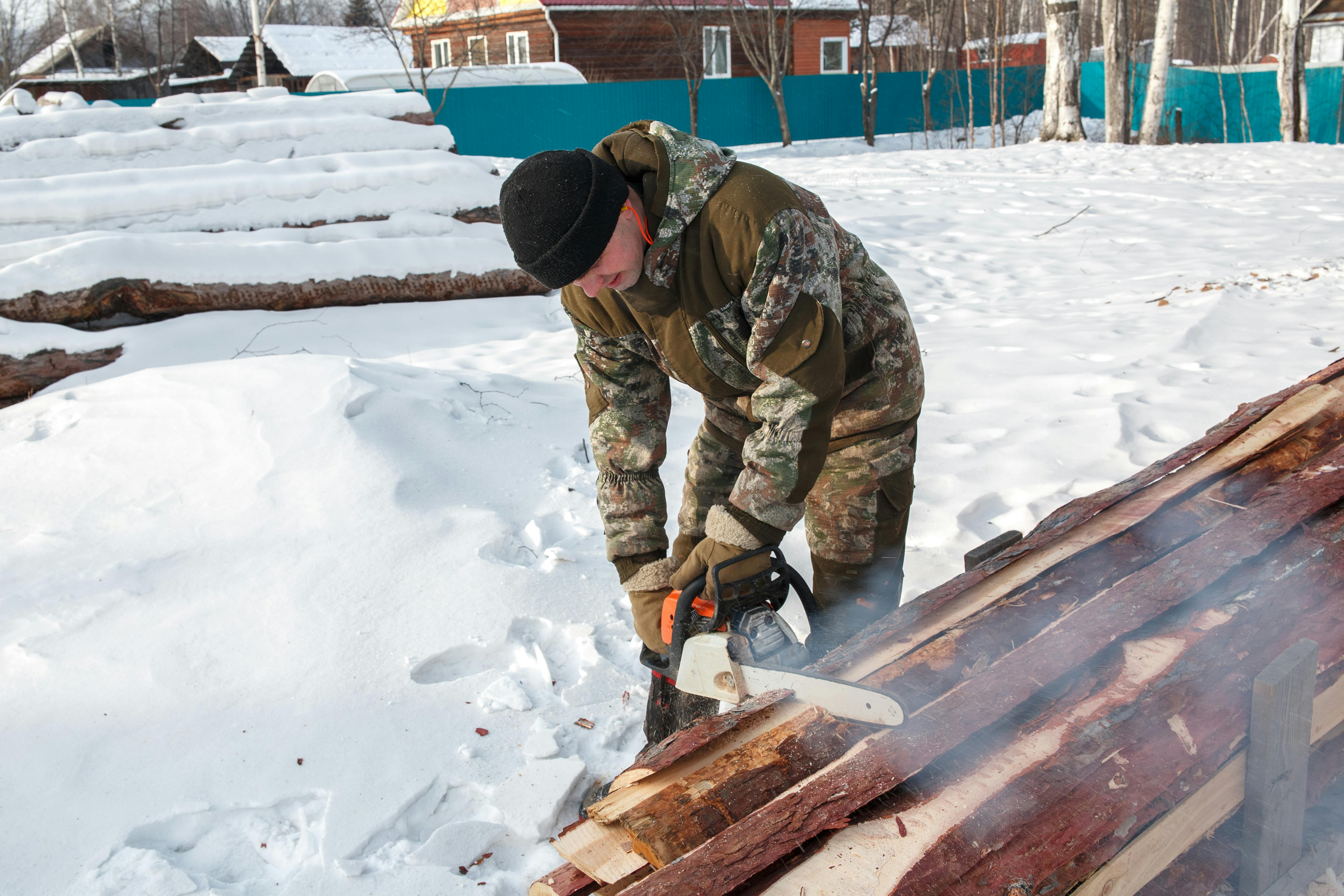Man Using a Chainsaw · Free Stock Photo