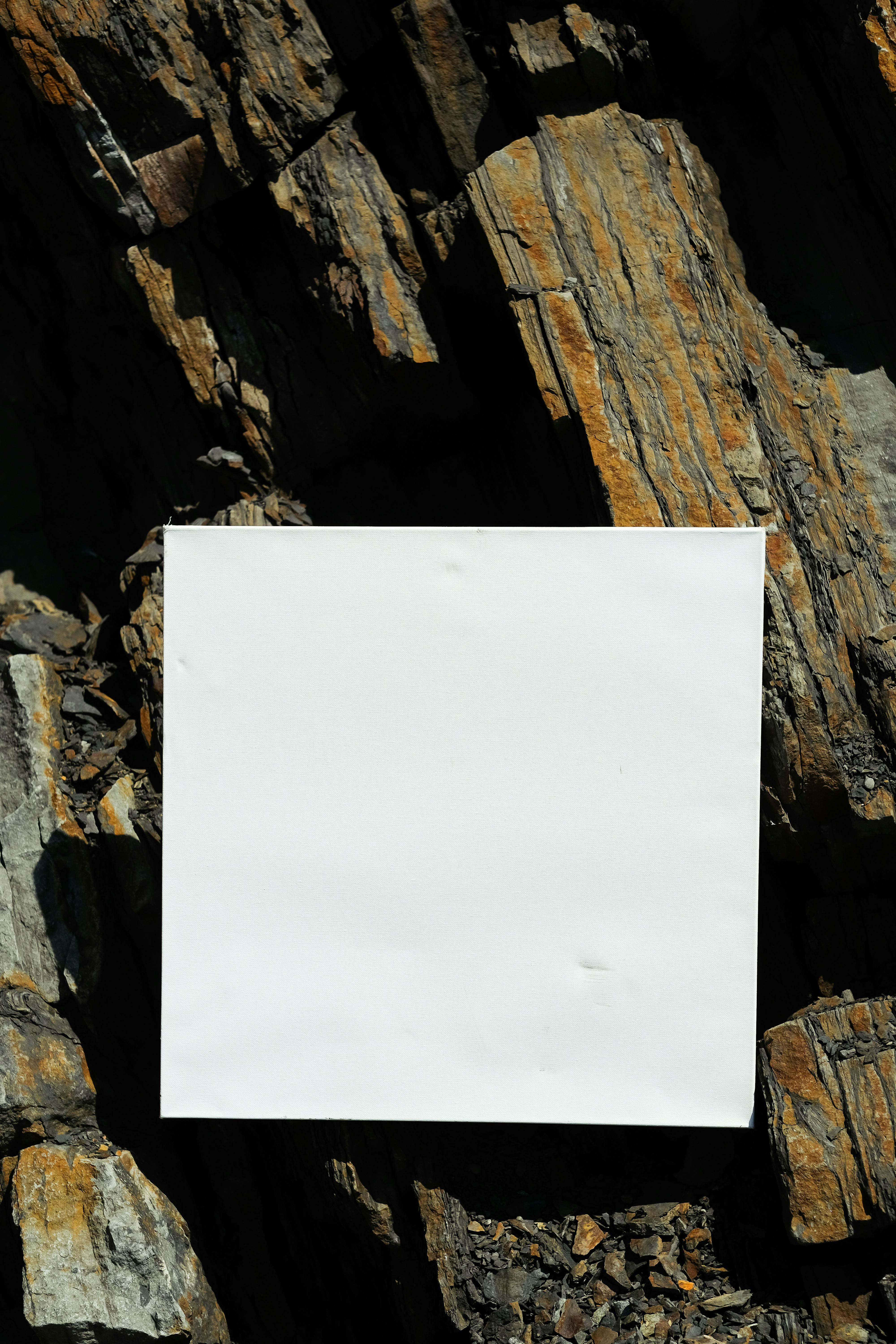 A White Printer Paper on Brown Rock · Free Stock Photo