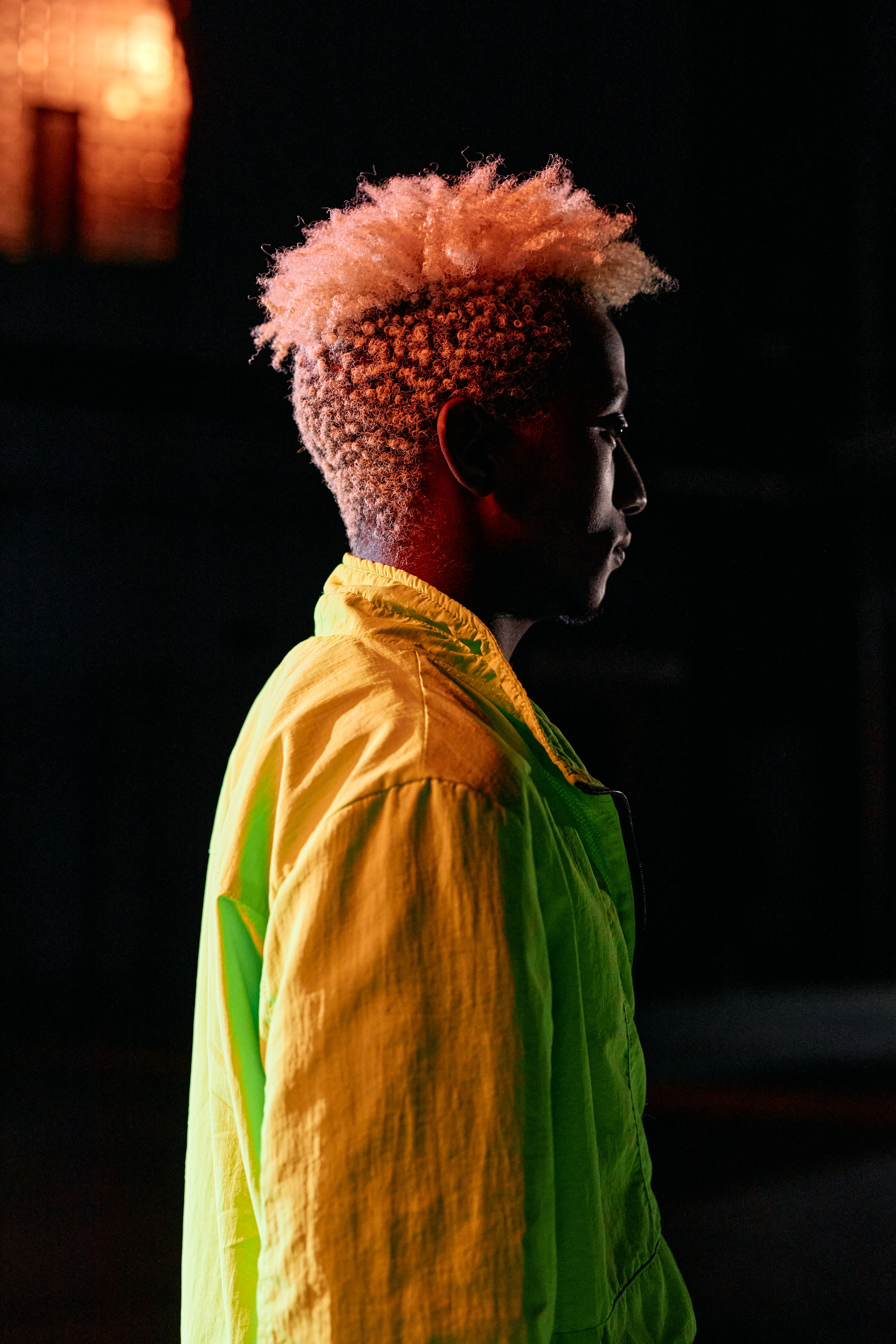 A Sad Man Wearing Neon Green Jacket while Looking Afar · Free Stock Photo