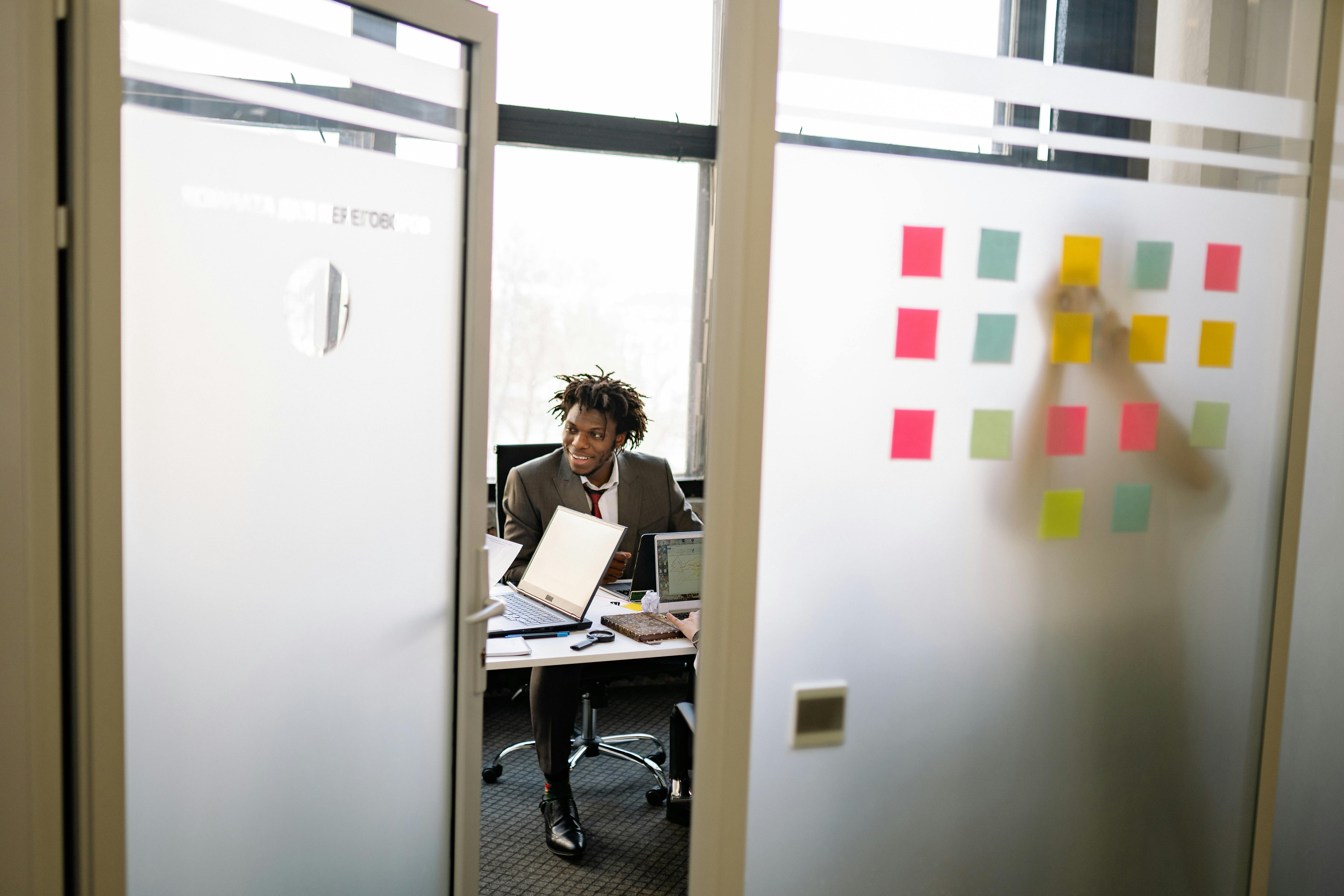 Man Standing in a Conference Room · Free Stock Photo