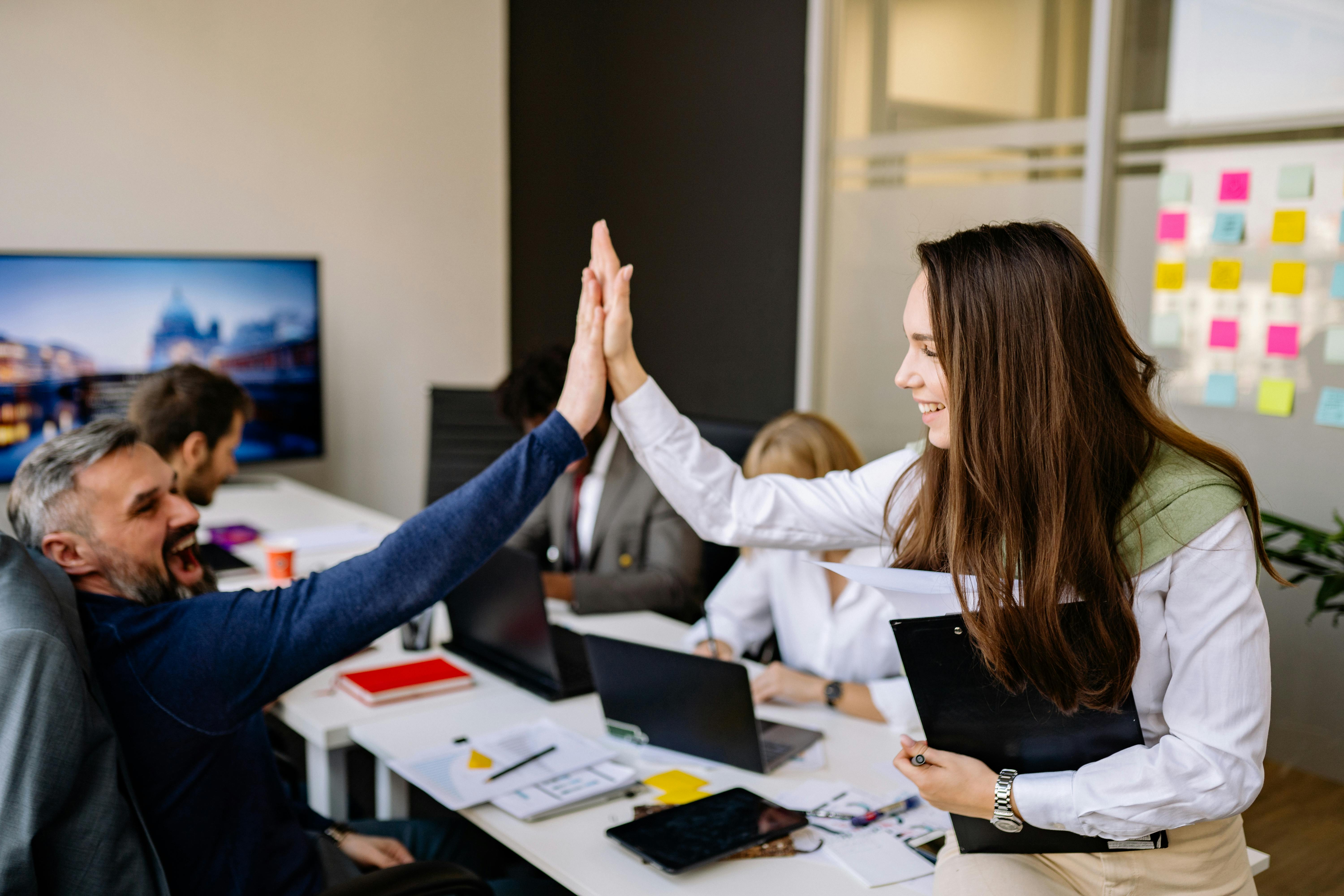 A Woman Giving a High Five to Her Colleague · Free Stock Photo