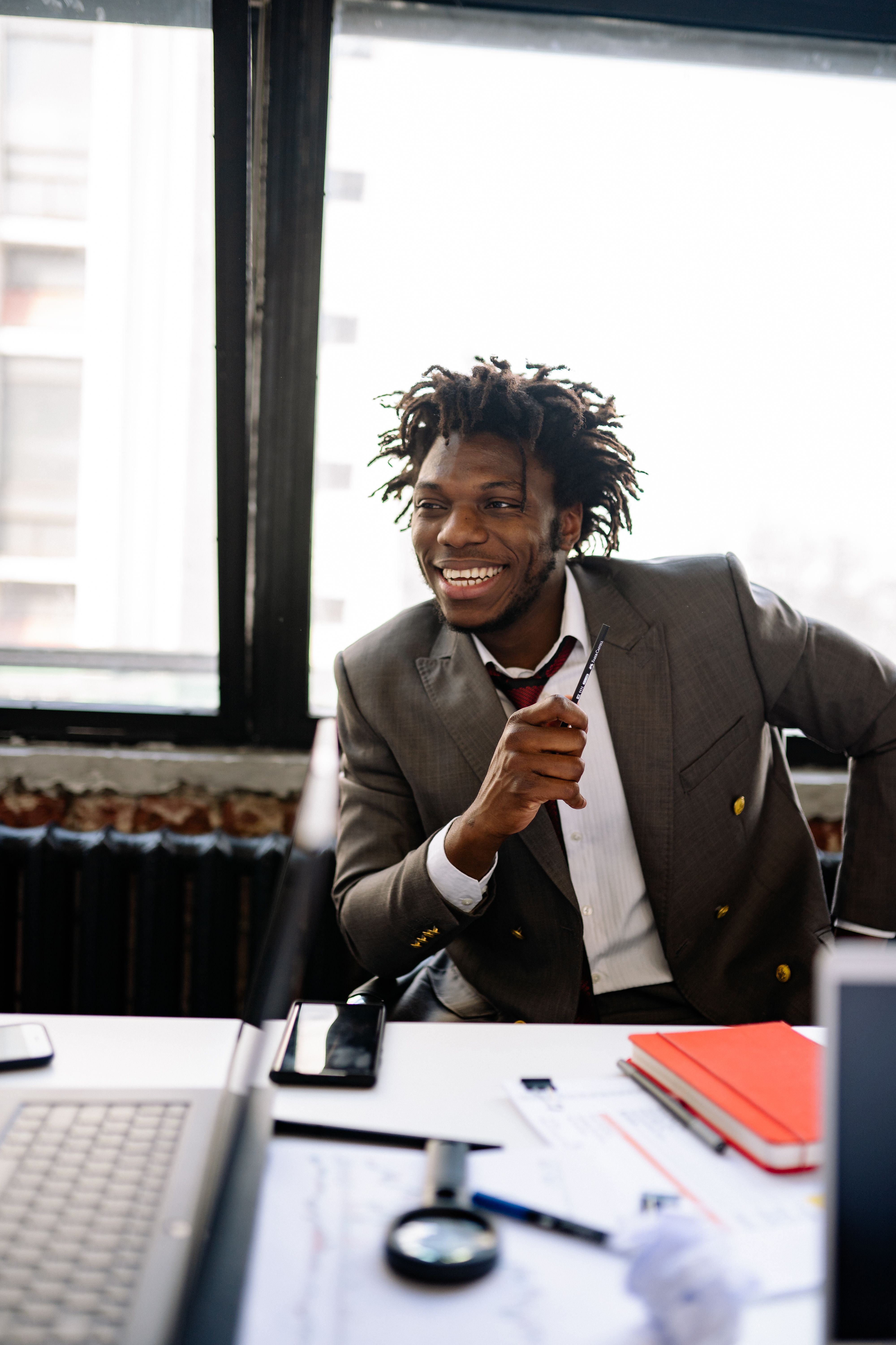 A Smiling Man Wearing a Corporate Attire · Free Stock Photo