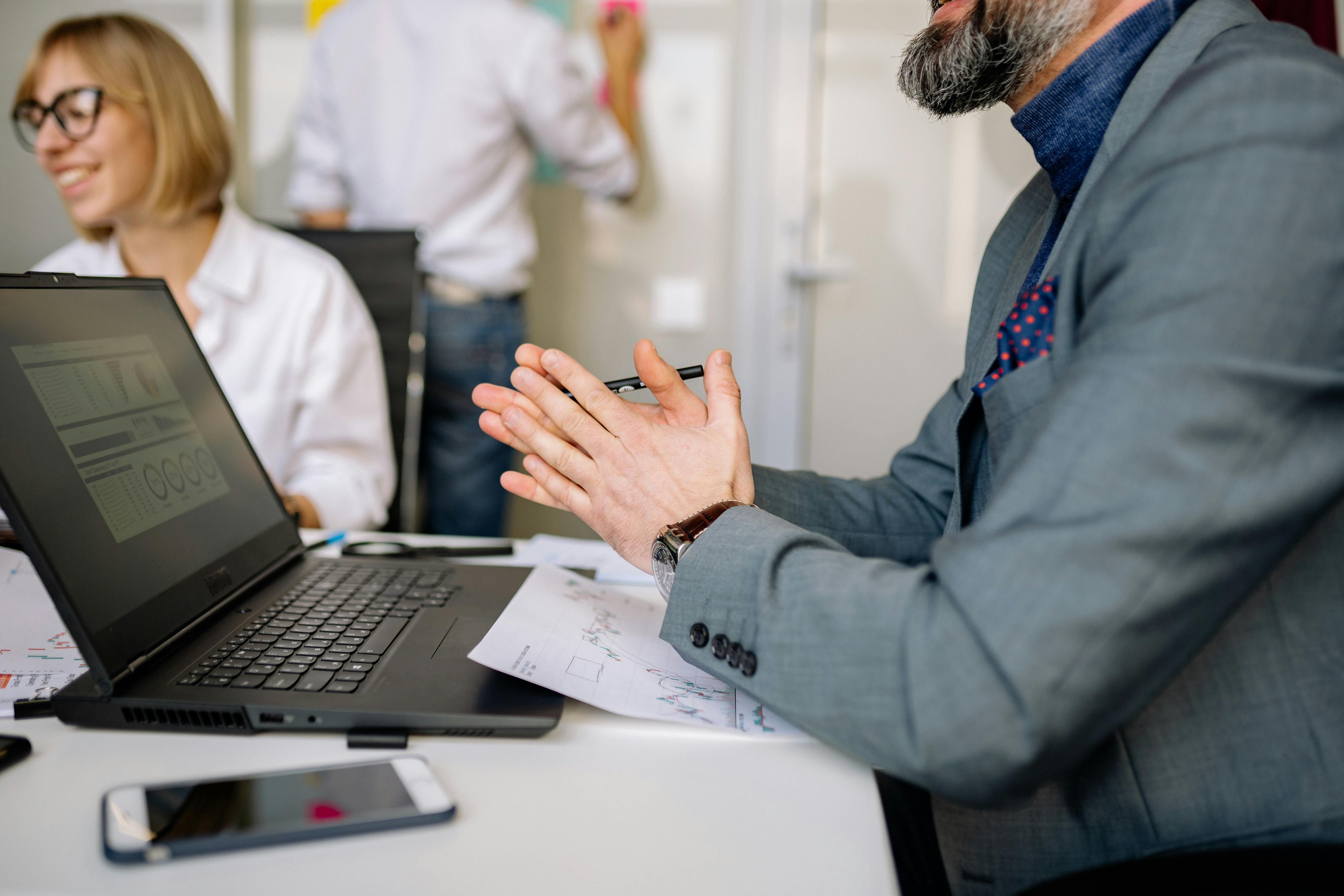 Man in Gray Suit Jacket Using Laptop Computer · Free Stock Photo