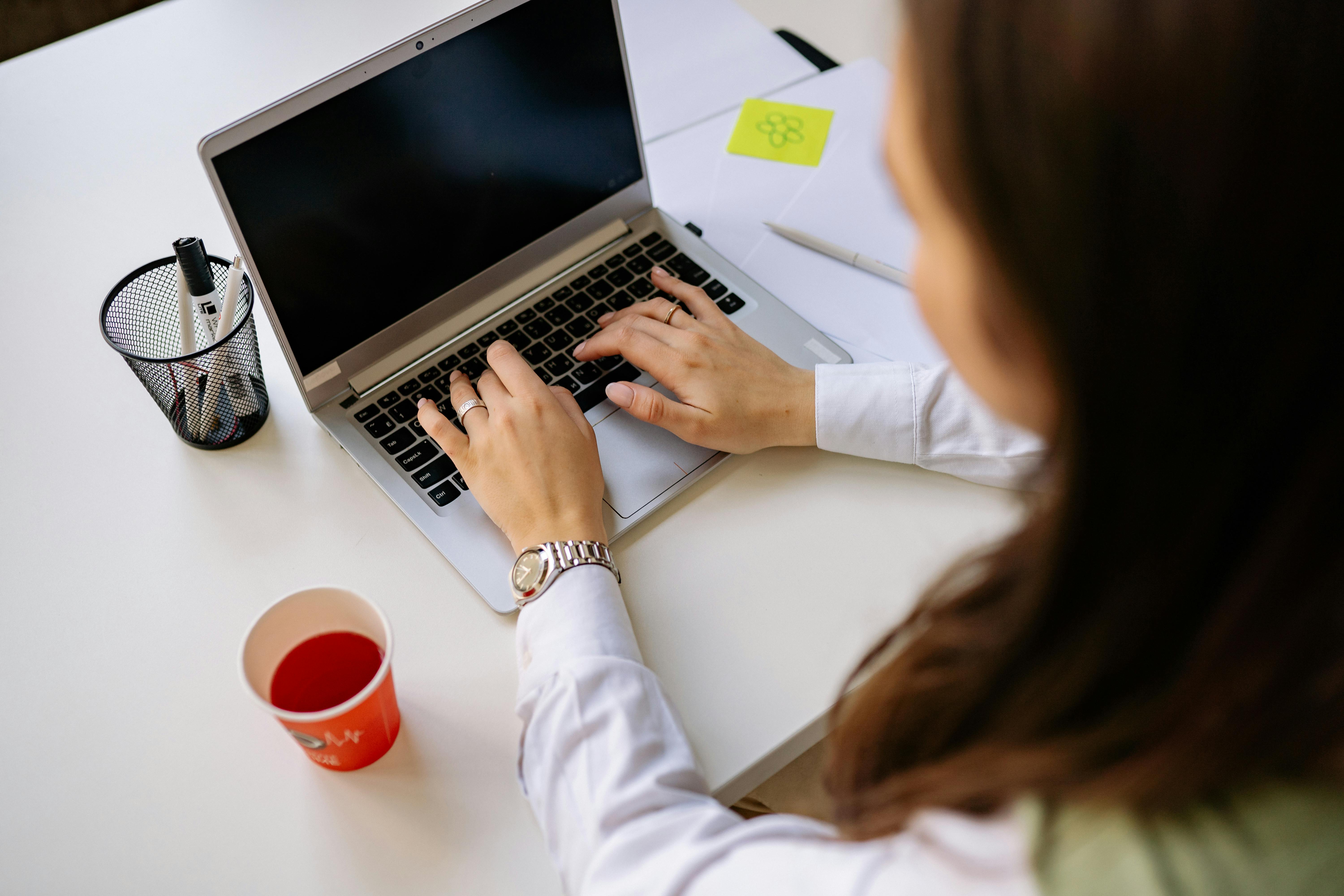 Person Using Smartphone and Laptop · Free Stock Photo